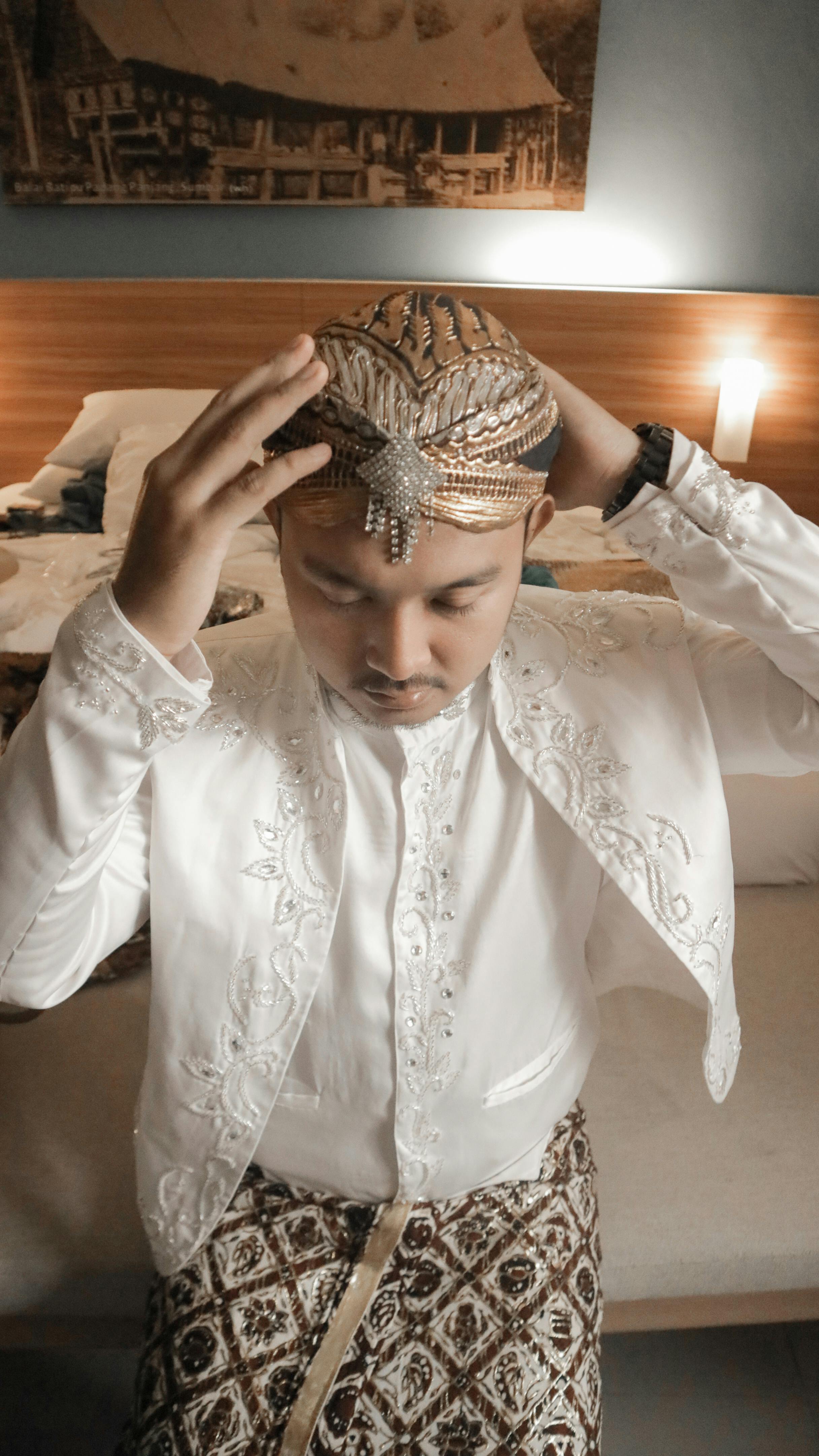Photo of a Man Dressing up in a Traditional Clothing · Free Stock Photo