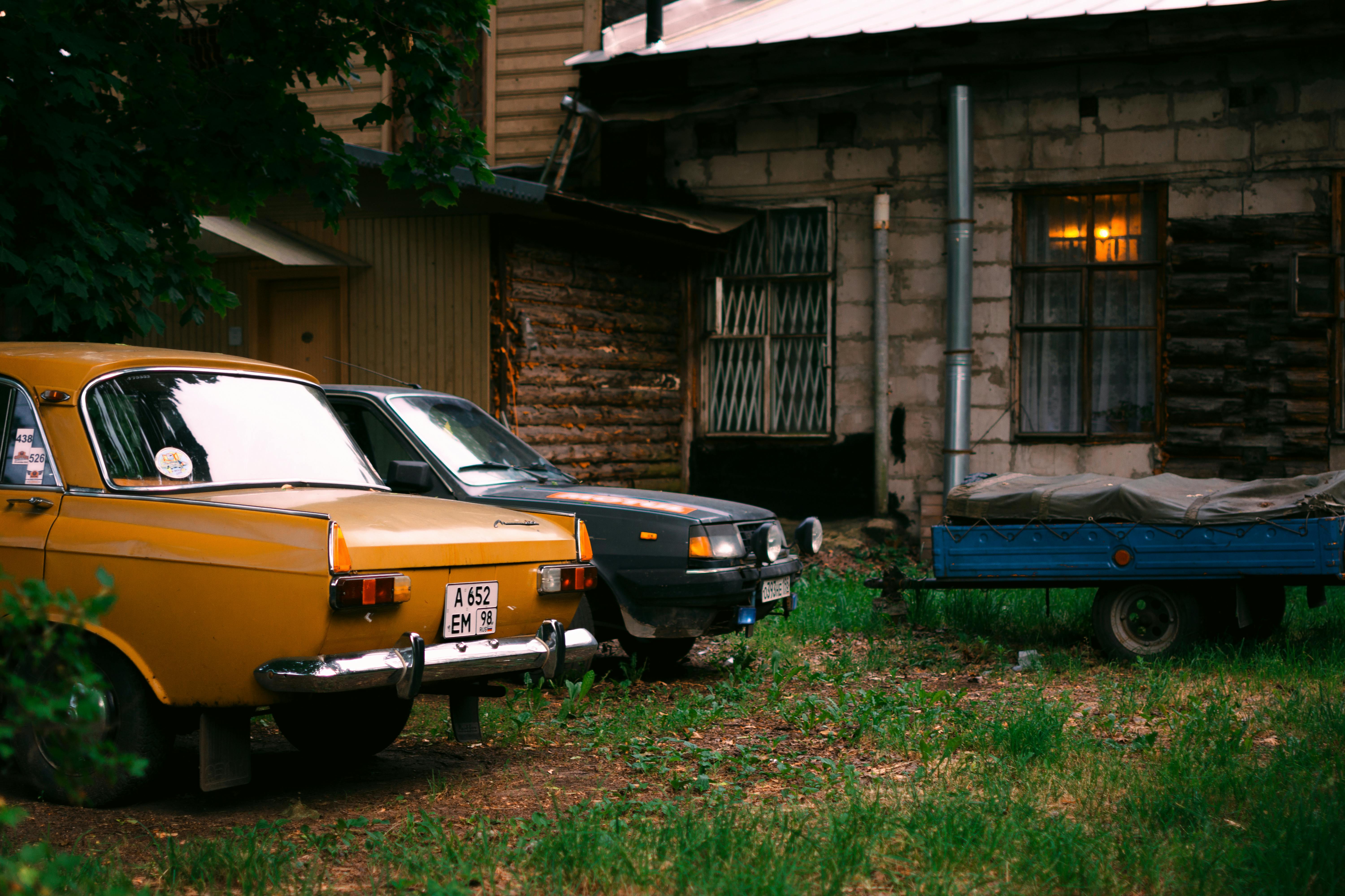 Vintage Cars on a Yard in front of a House · Free Stock Photo