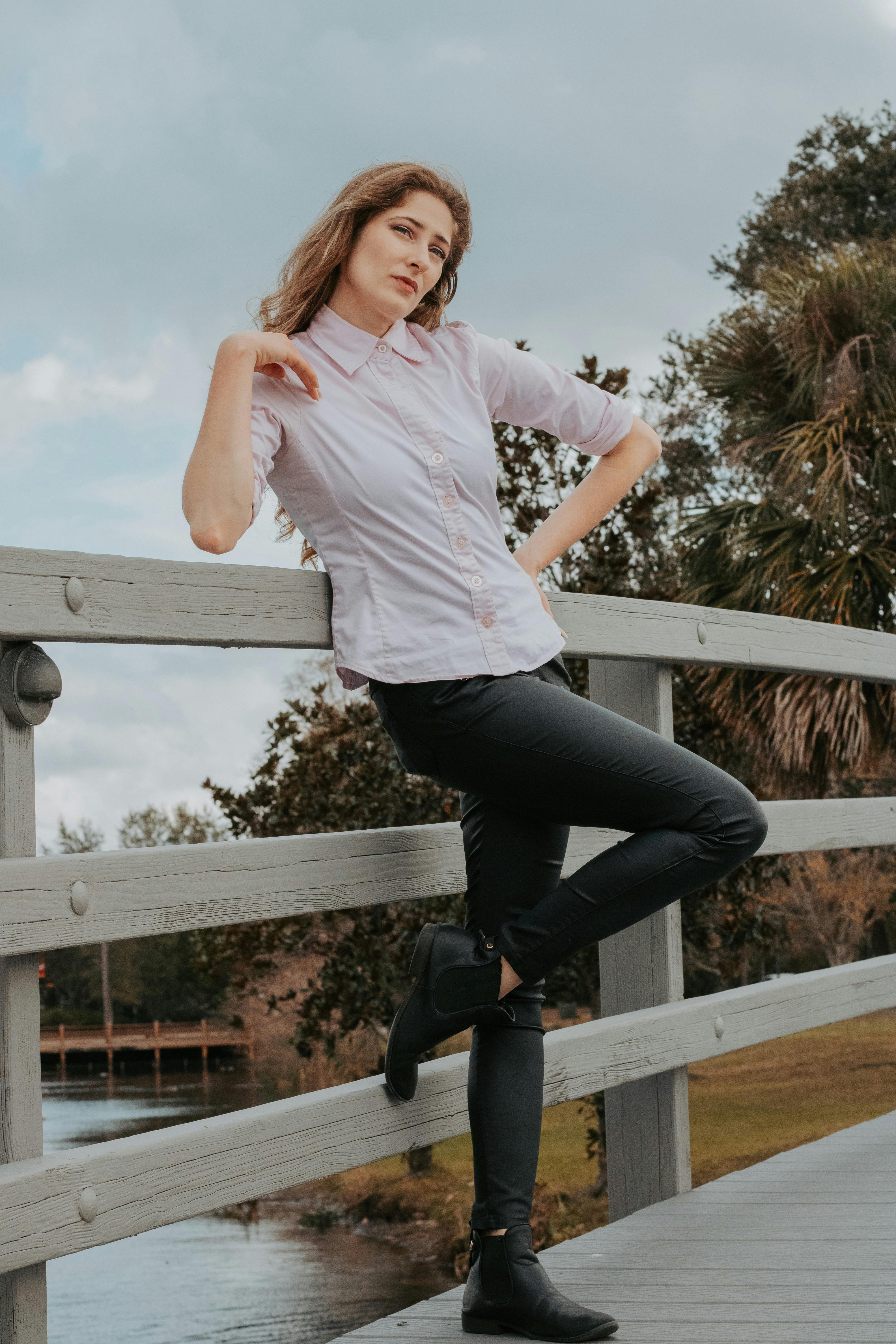 Woman in Shirt Posing on Bridge · Free Stock Photo