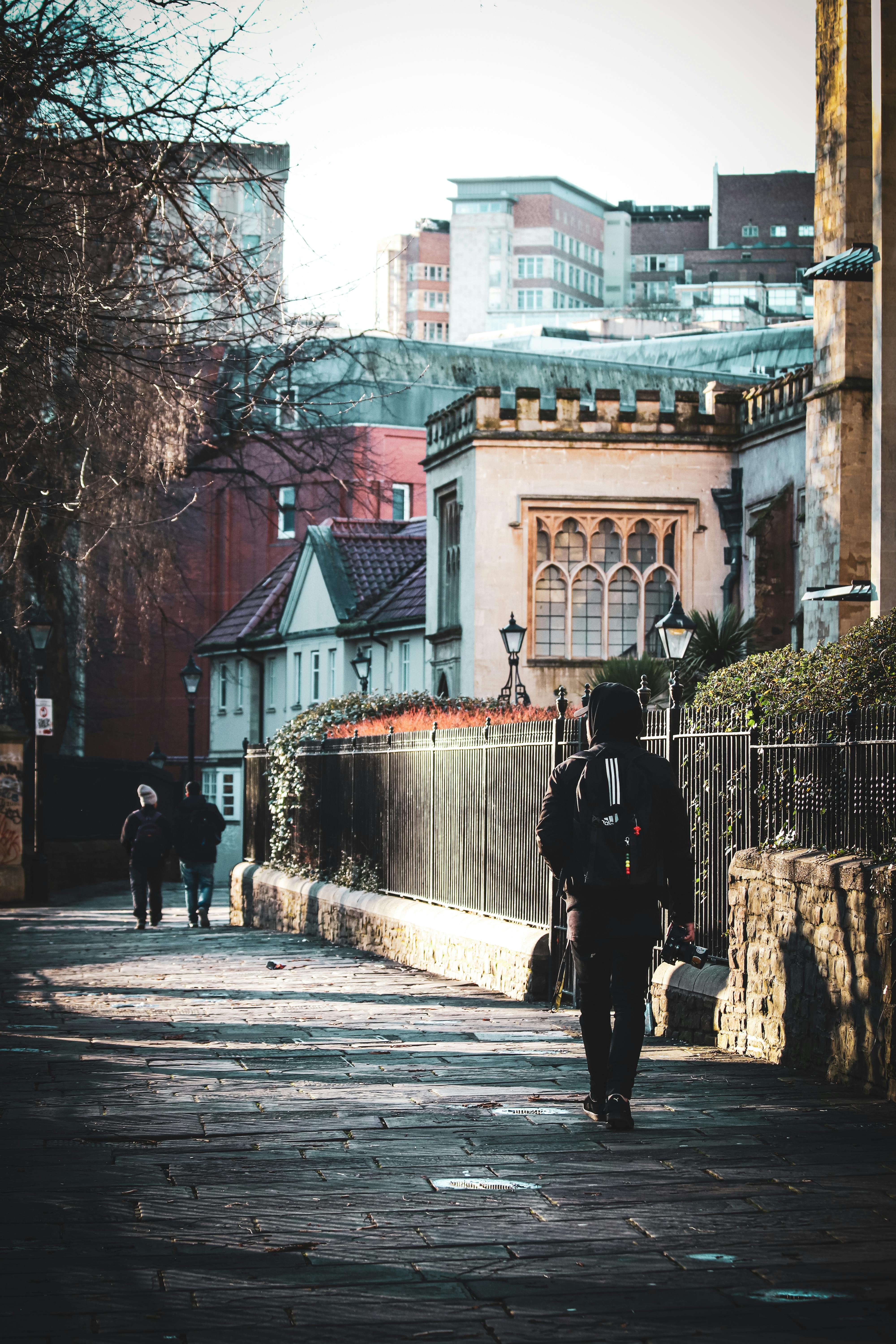Person Walking on Sidewalk in Town · Free Stock Photo