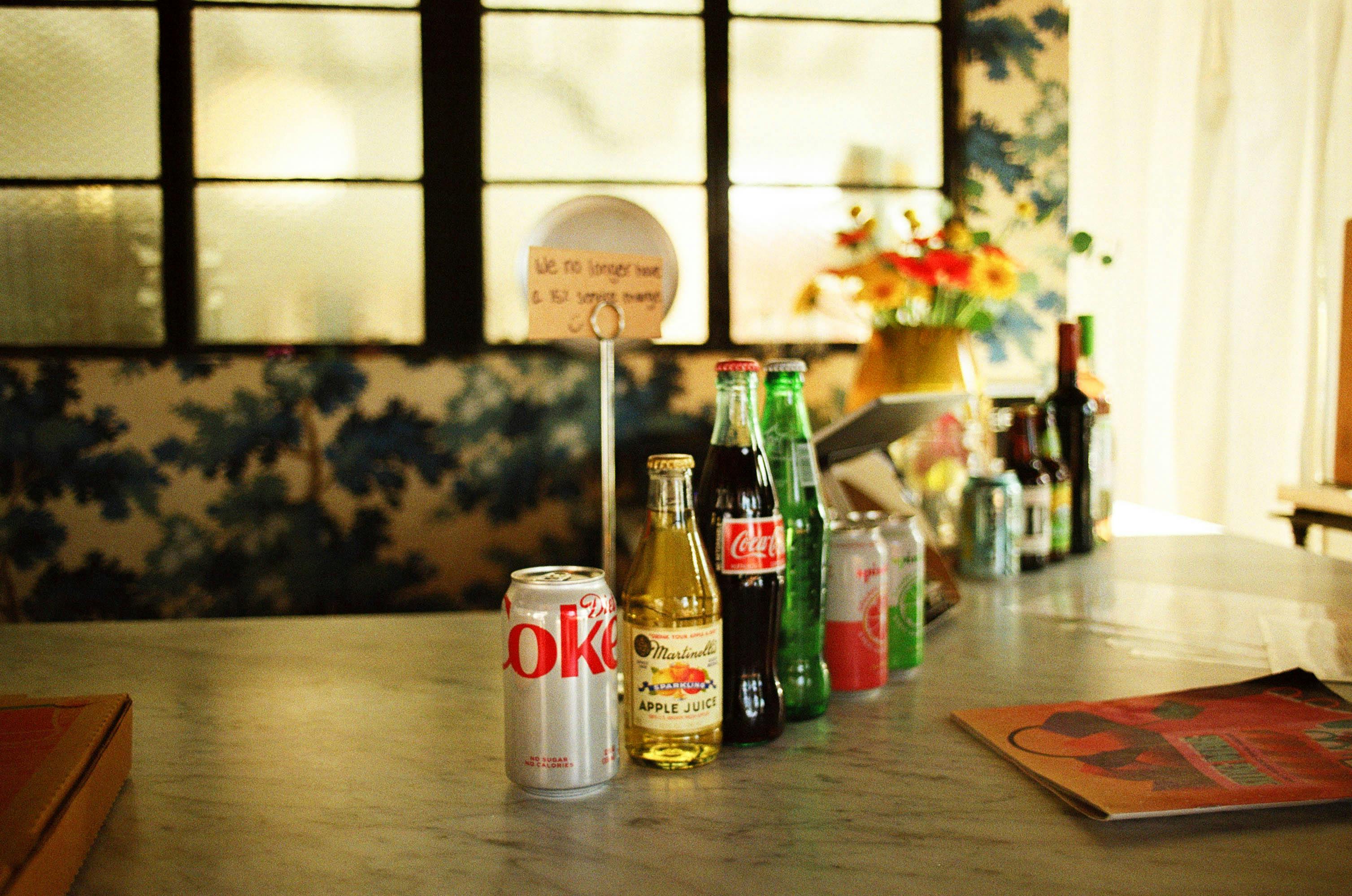 Cans and Bottles of Drinks in a Row · Free Stock Photo