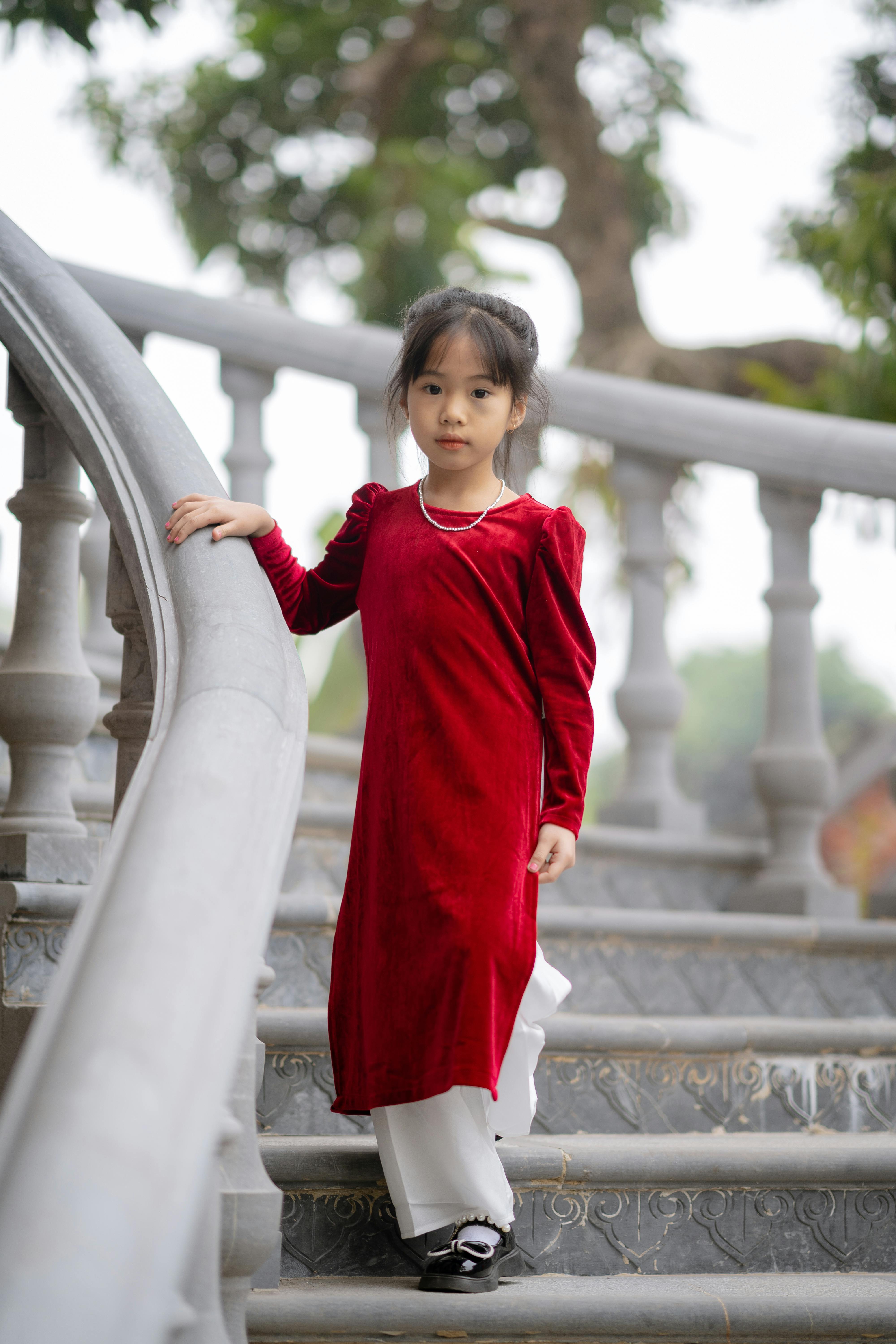 Girl Posing in Red Dress on Stairs · Free Stock Photo