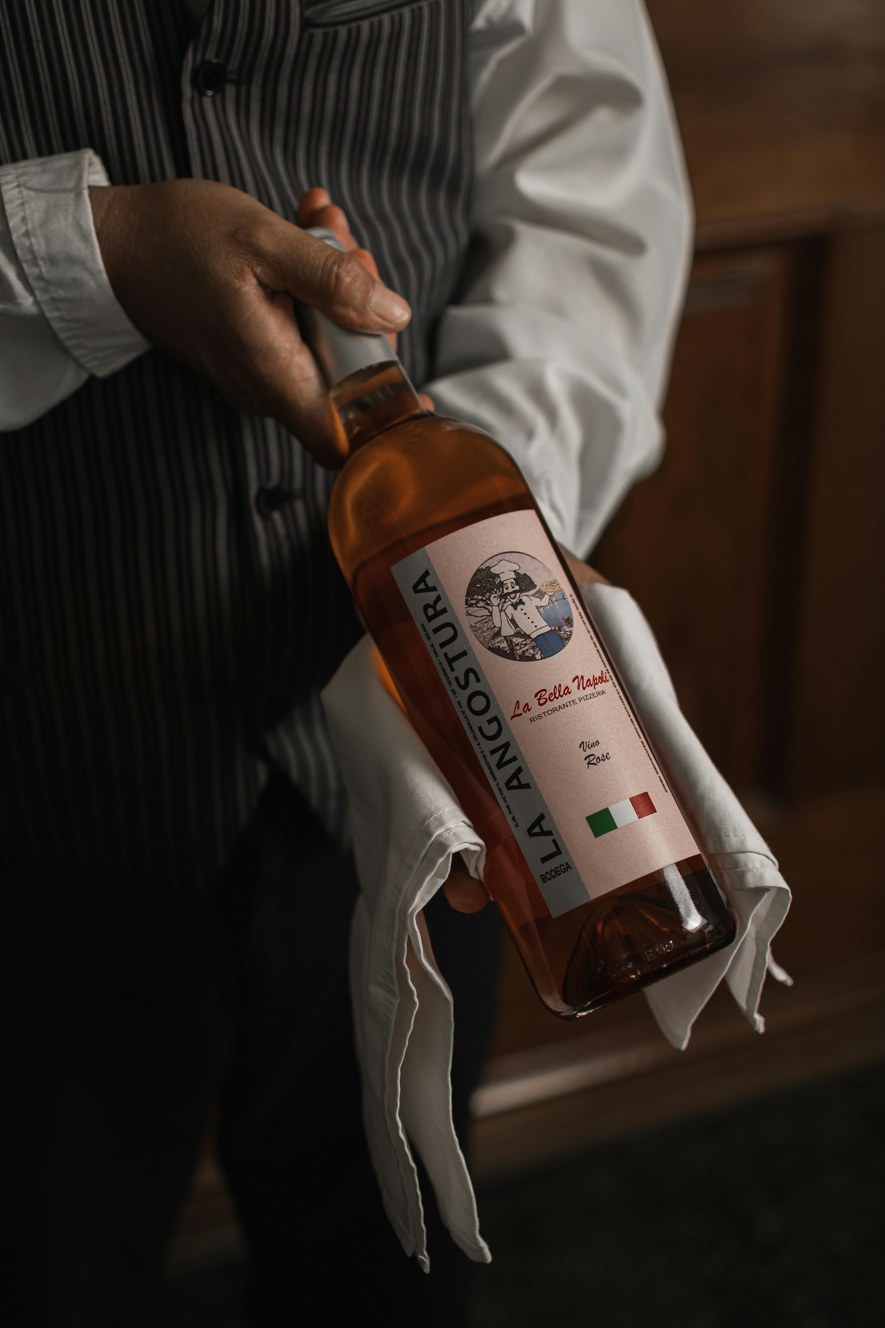 Waiter Presenting Bottle of Wine in Restaurant · Free Stock Photo