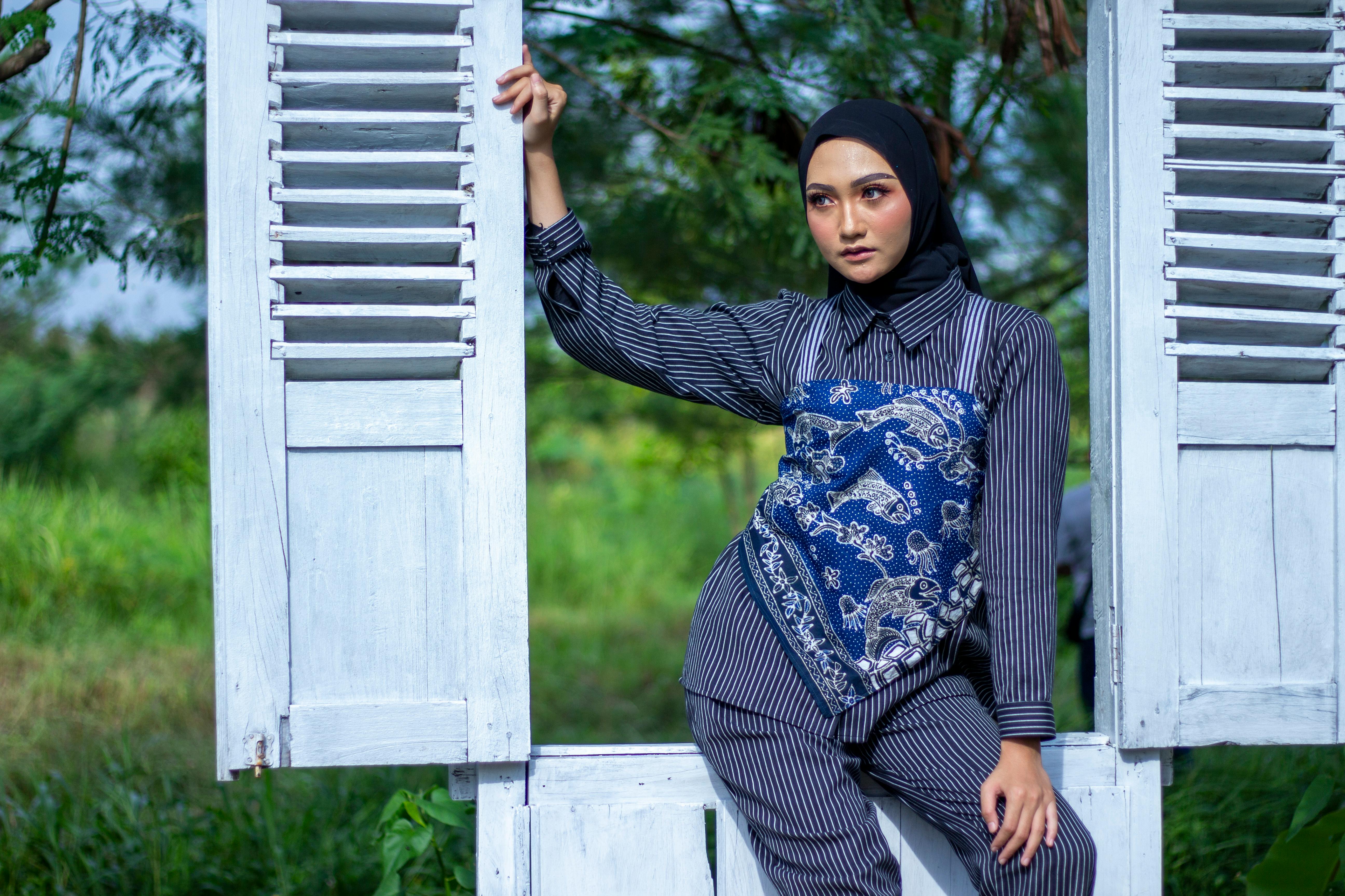 Woman Posing between Wooden Shutters · Free Stock Photo
