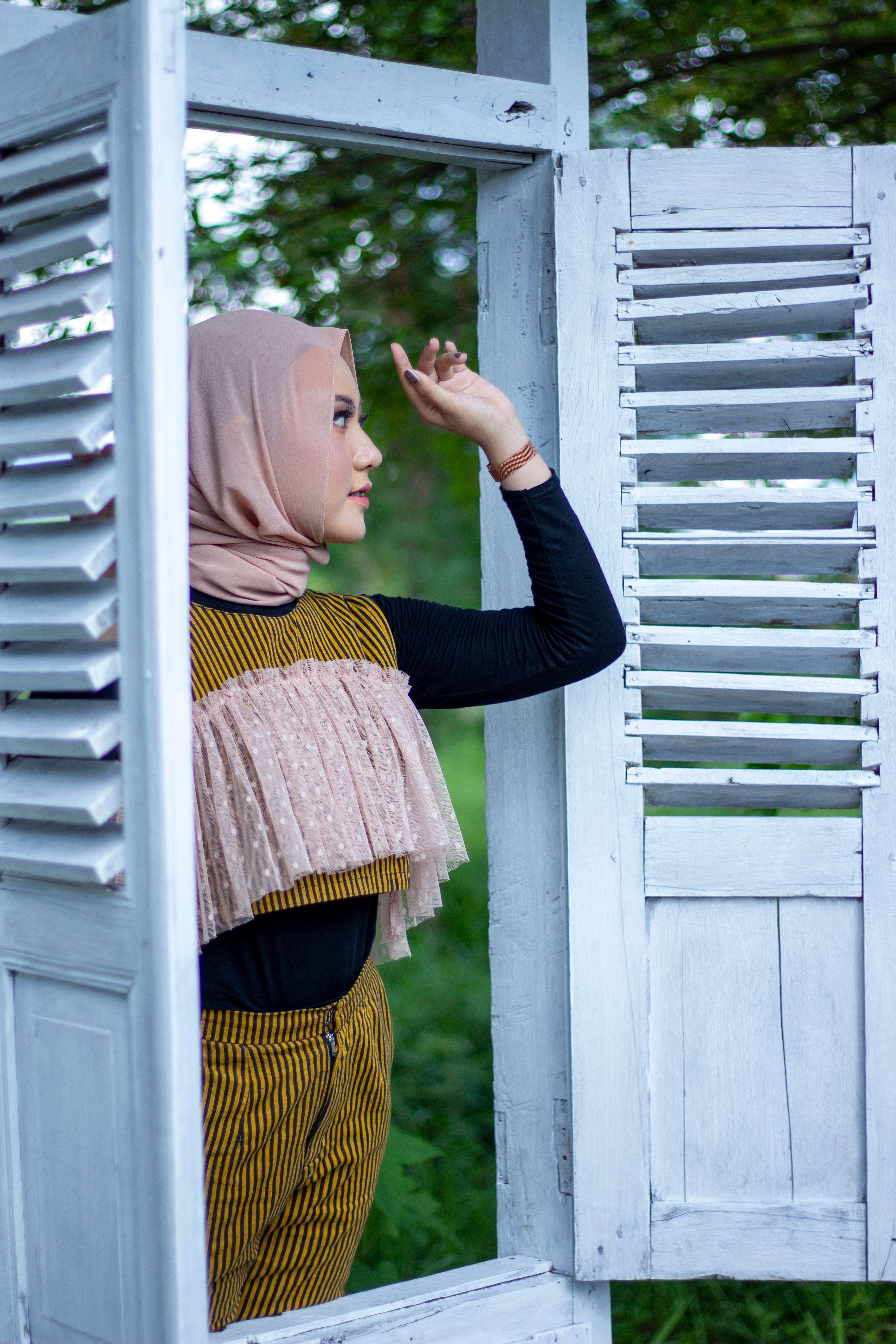 Woman Posing between Shutters · Free Stock Photo