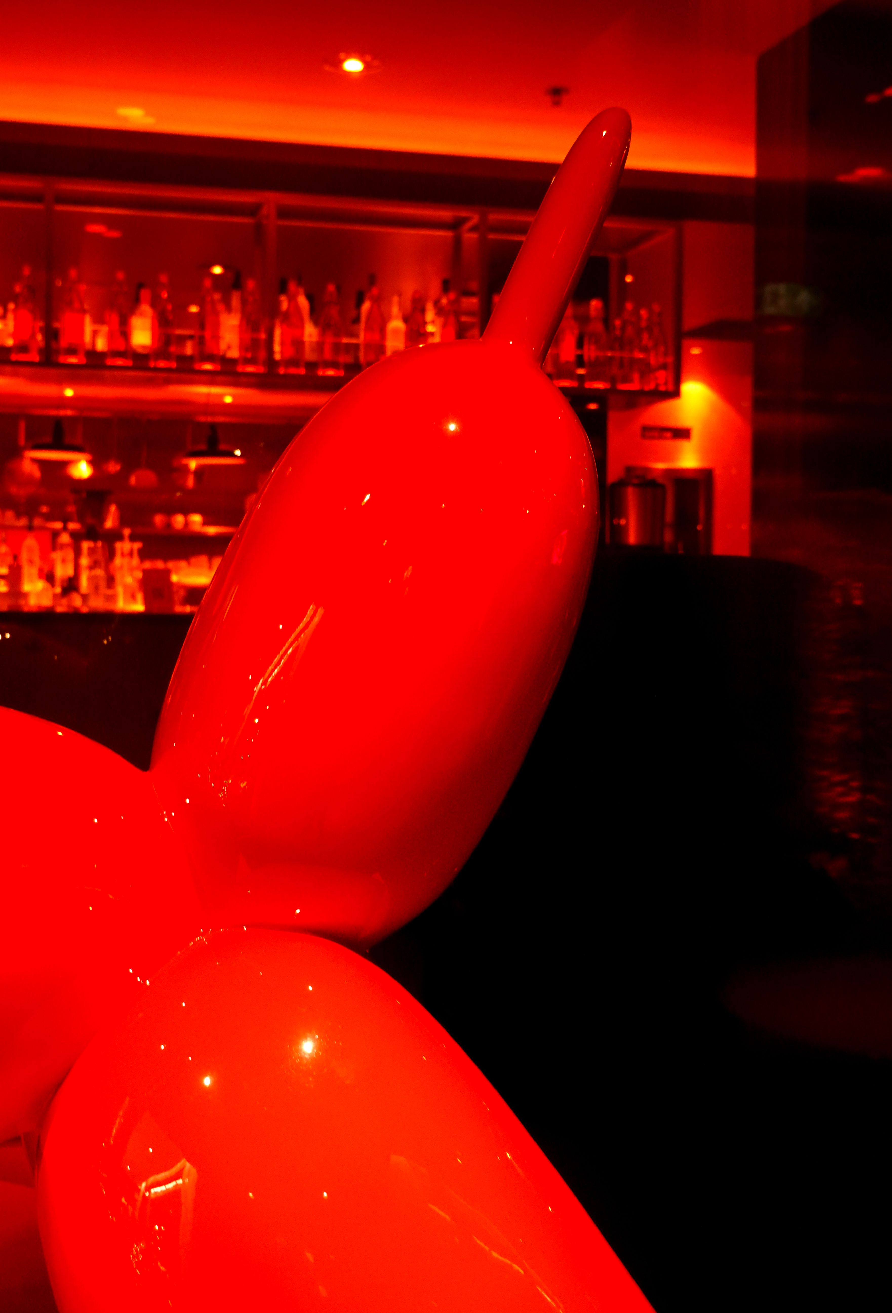 A red balloon sculpture in a bar · Free Stock Photo