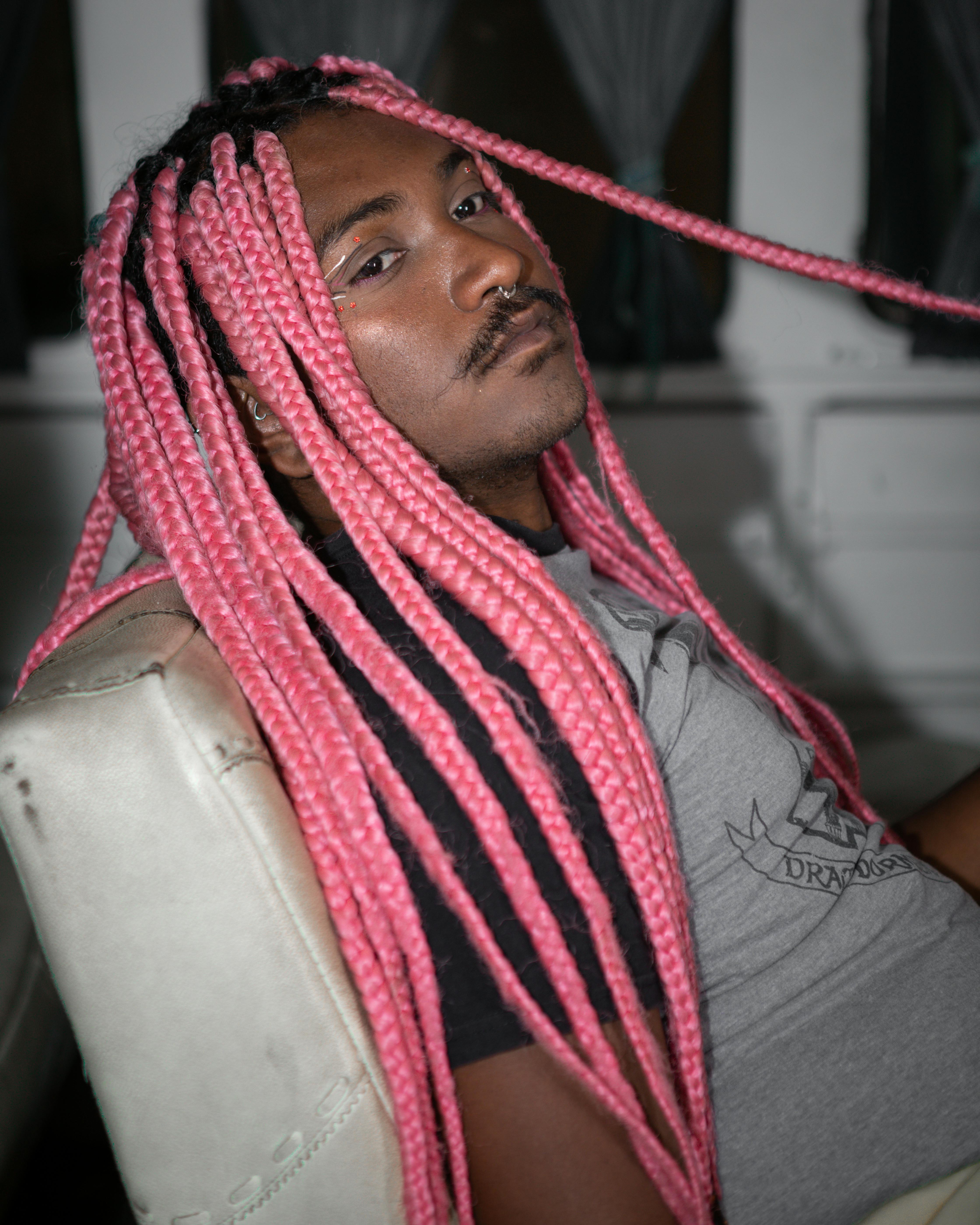 Young Man with Mustache Wearing Pink Artificial Braids · Free Stock Photo