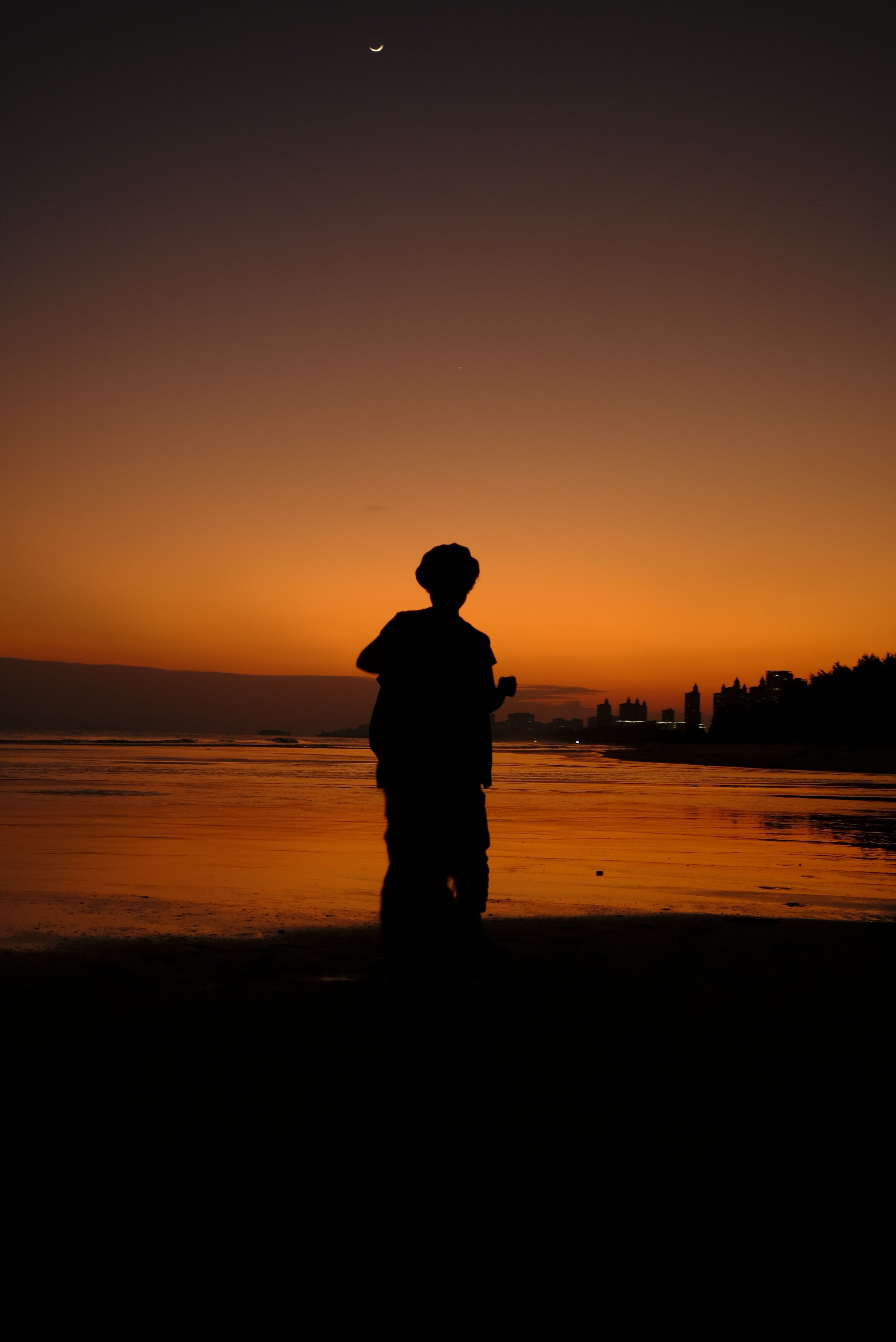Silhouette of a Person Standing near a Body of Water at Sunset · Free ...