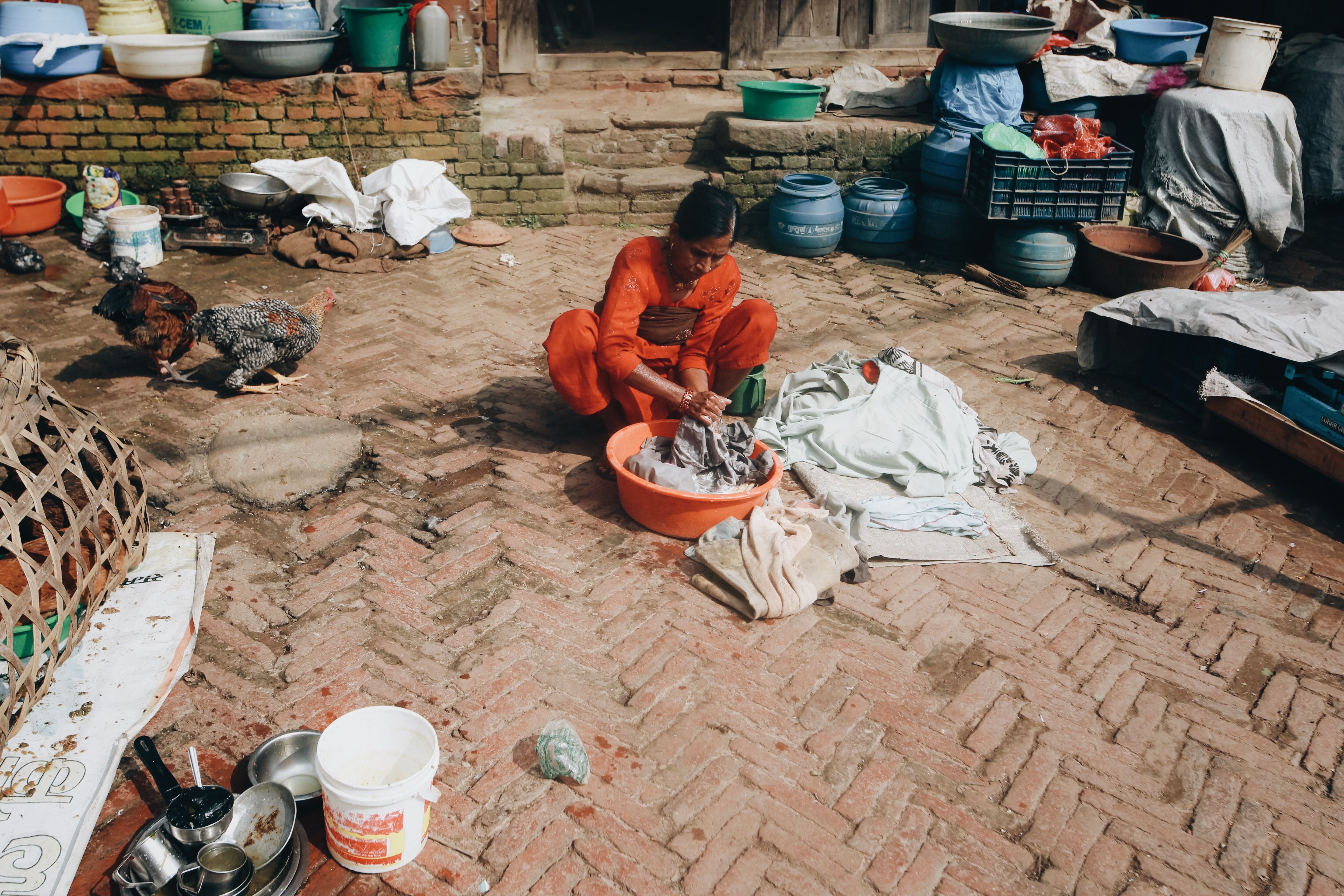 Woman Washing Clothes in Washbasin Outdoors · Free Stock Photo