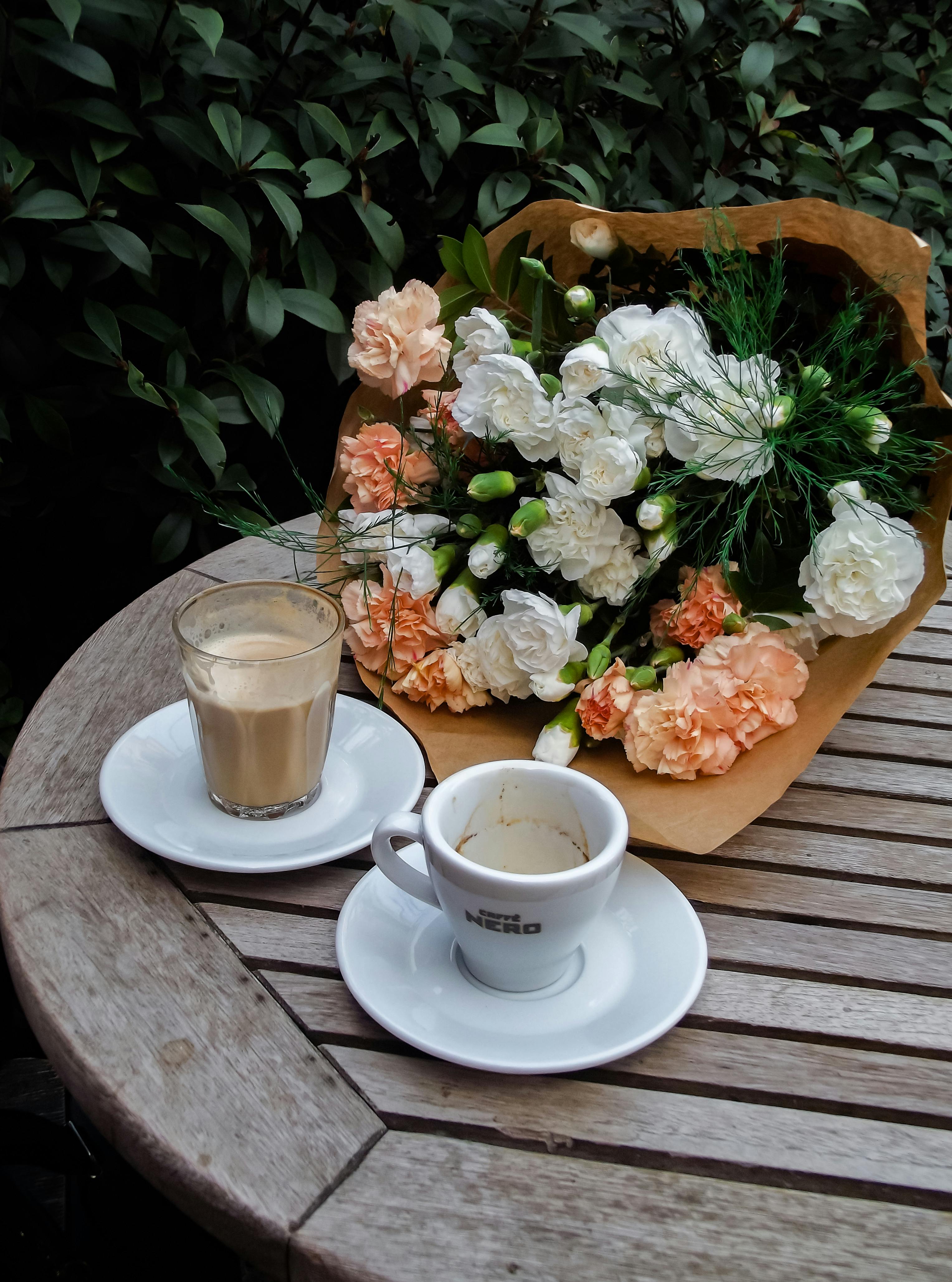 Two Coffees and a Bouquet on a Table · Free Stock Photo