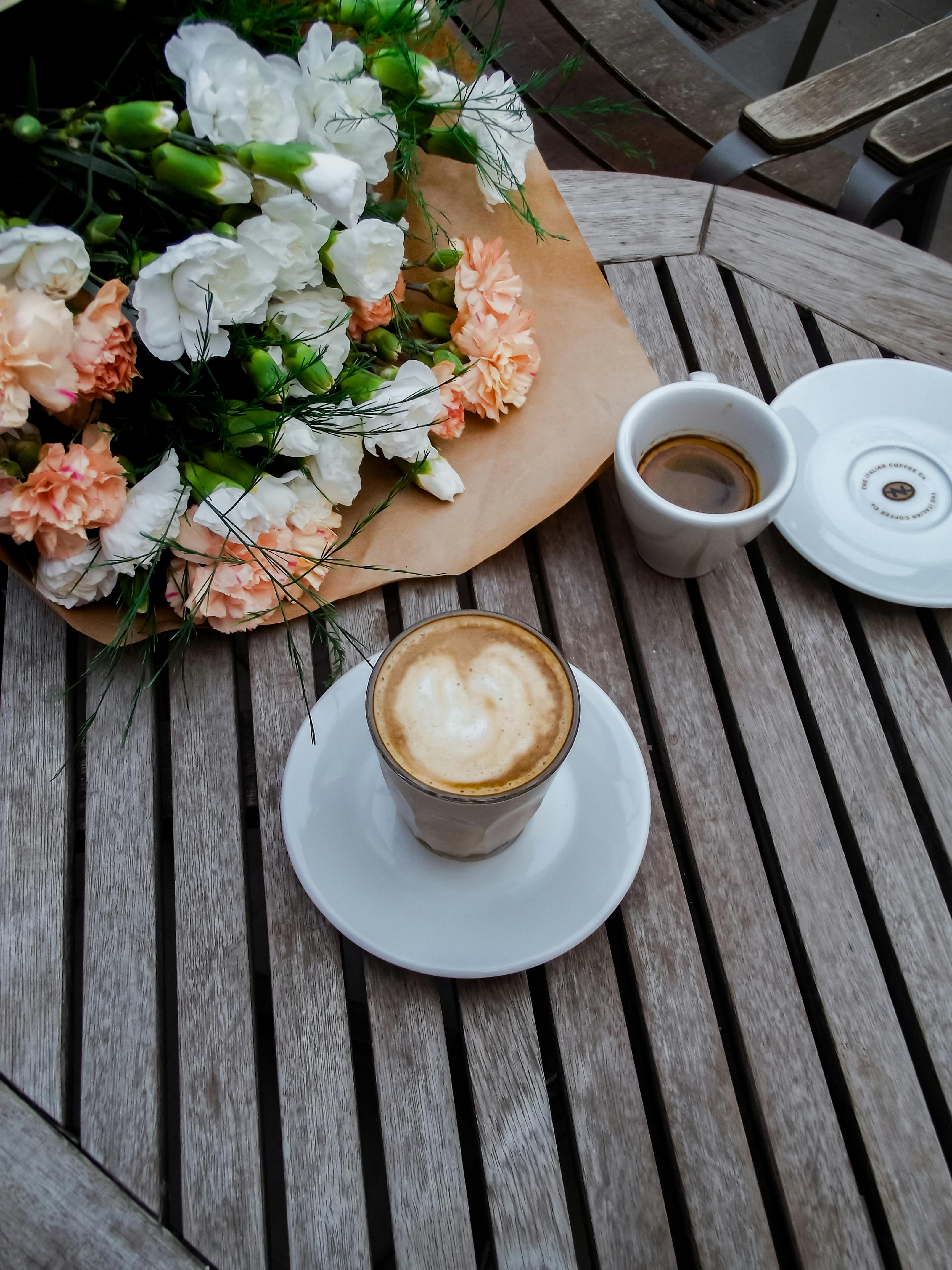 Close-up of Coffee and Bouquet of Flowers · Free Stock Photo