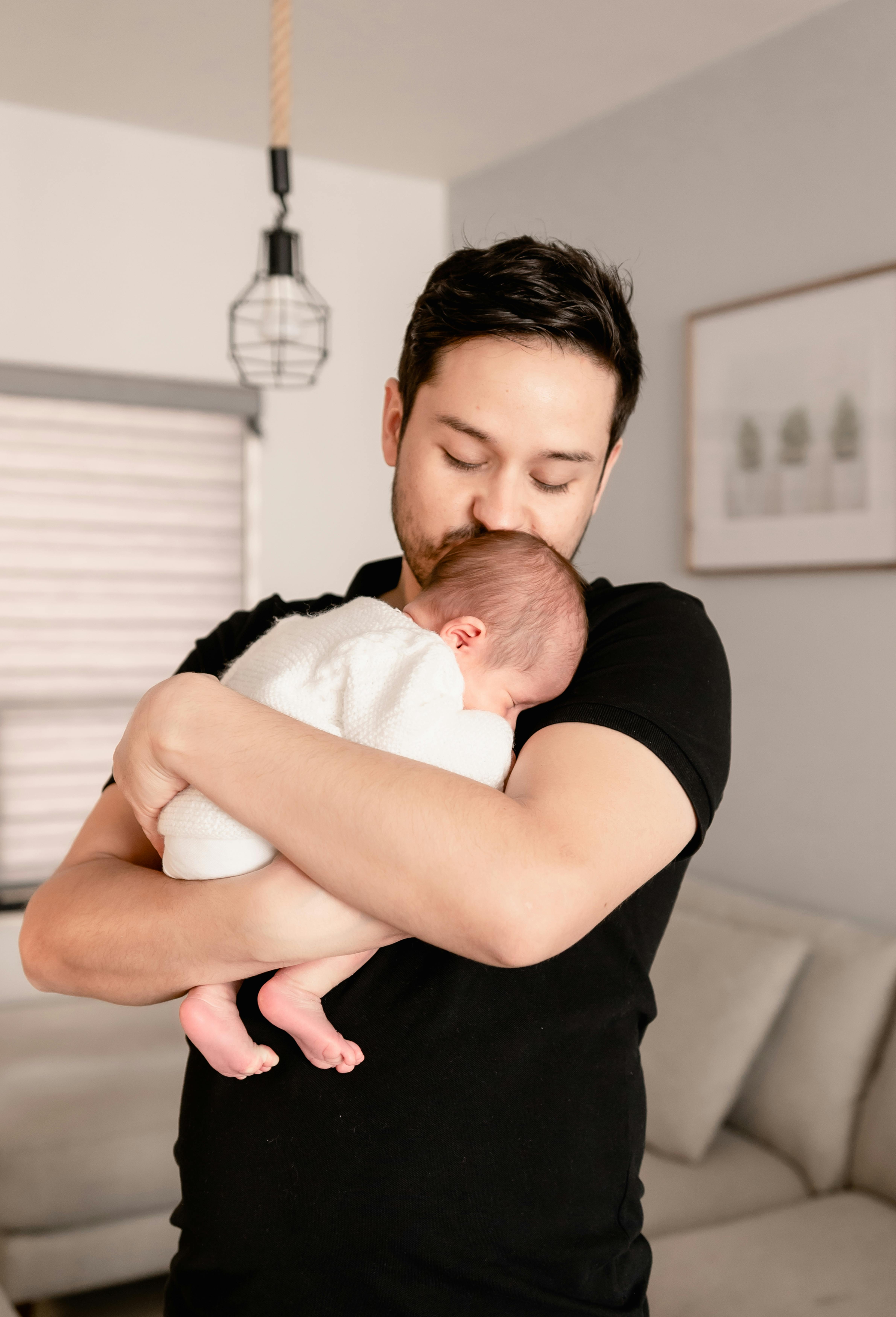 A Man Carrying a Baby Boy · Free Stock Photo