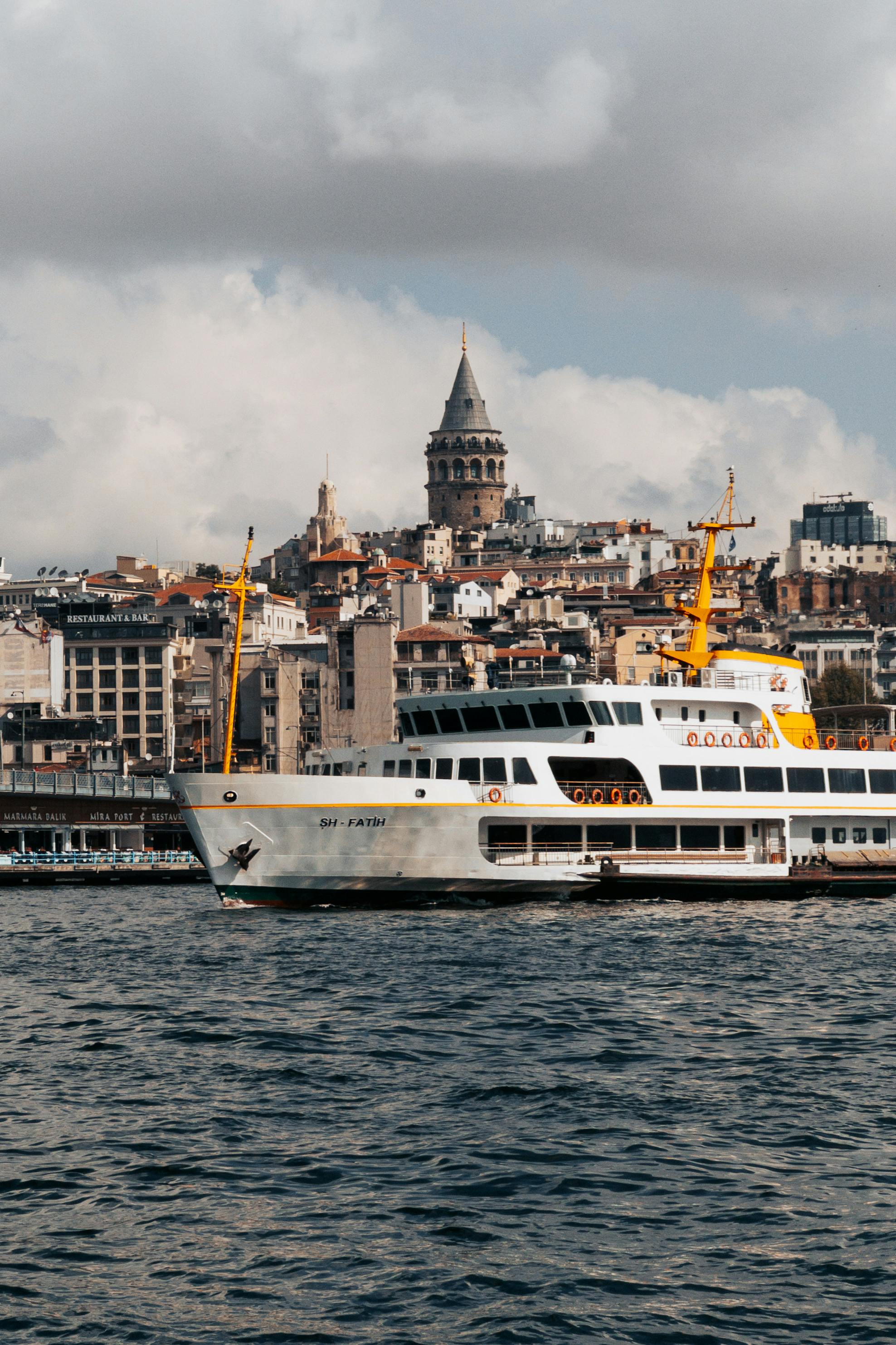 Ferry Sailing on Istanbul Coast with Galata Tower behind · Free Stock Photo