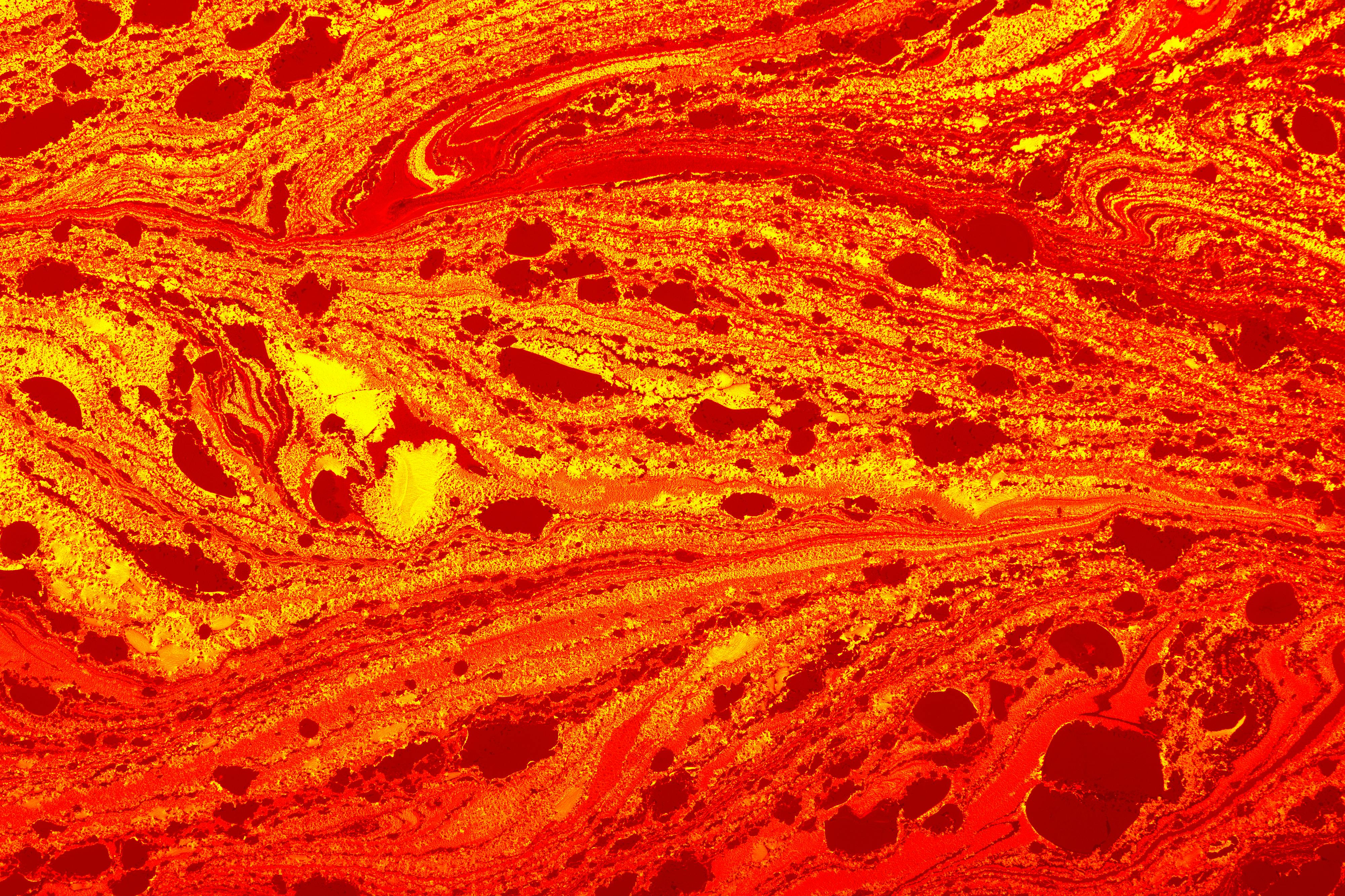 A red and orange liquid with swirls · Free Stock Photo