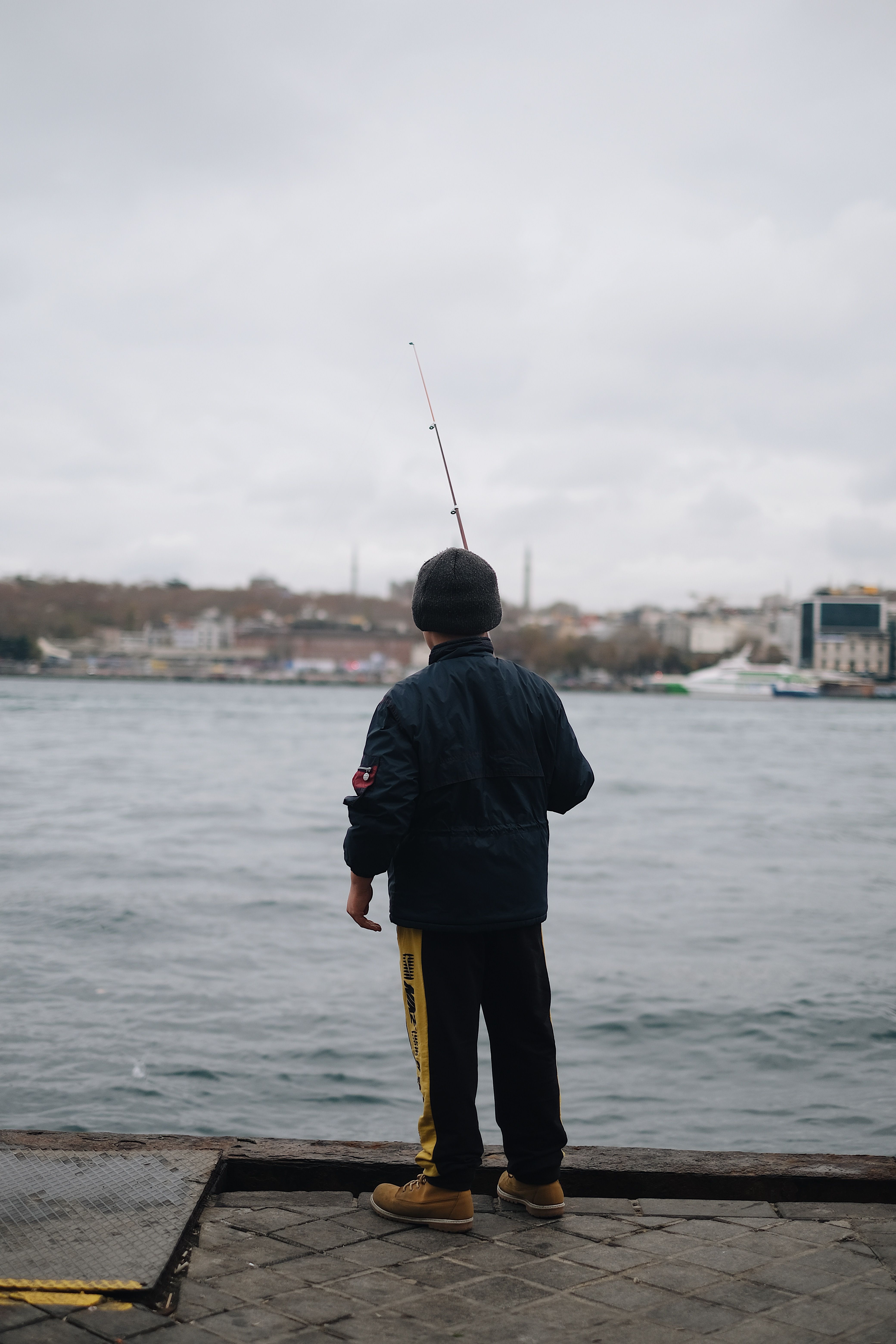 Person Fishing from Bridge · Free Stock Photo