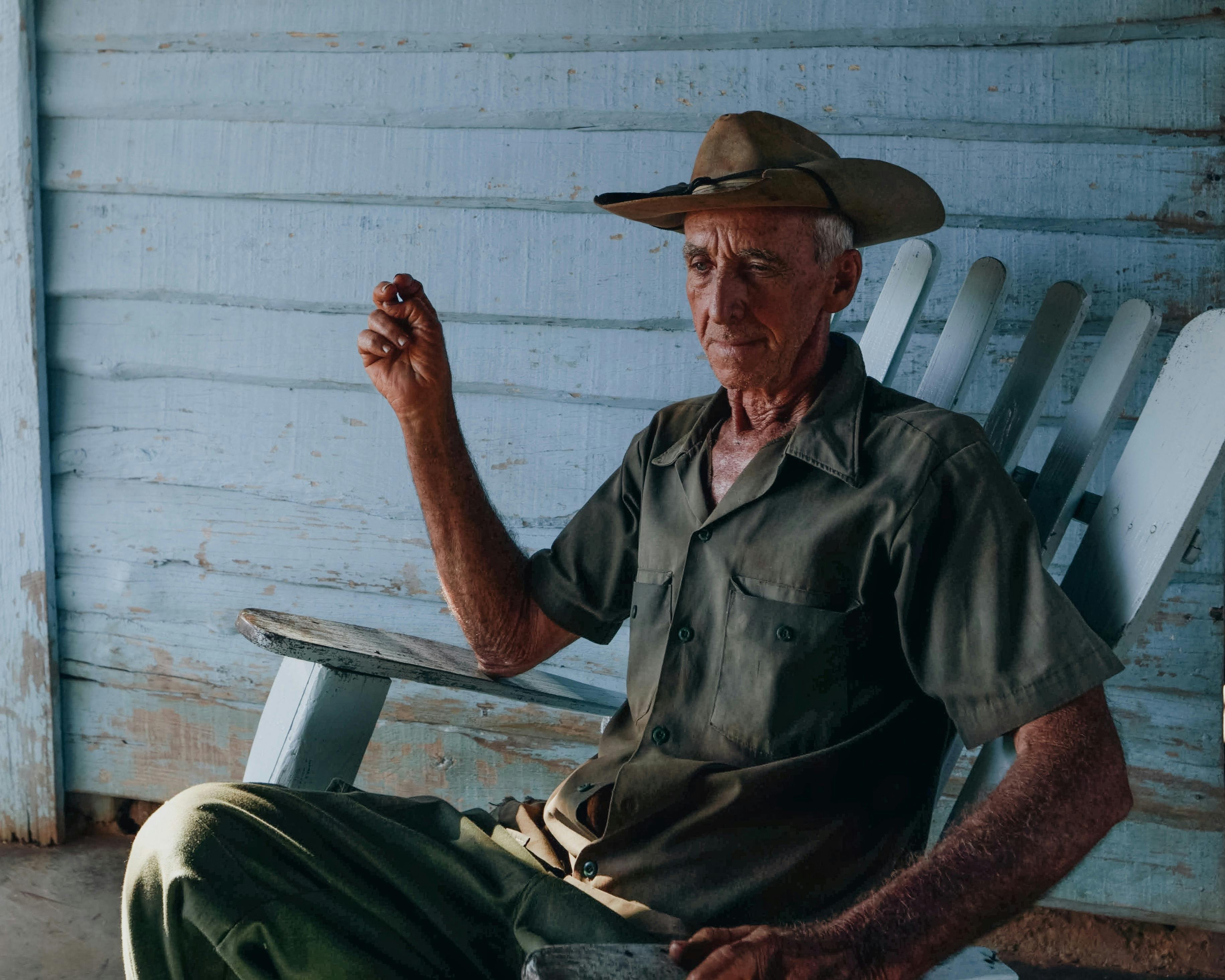 Man Sitting on Wooden Armchair · Free Stock Photo