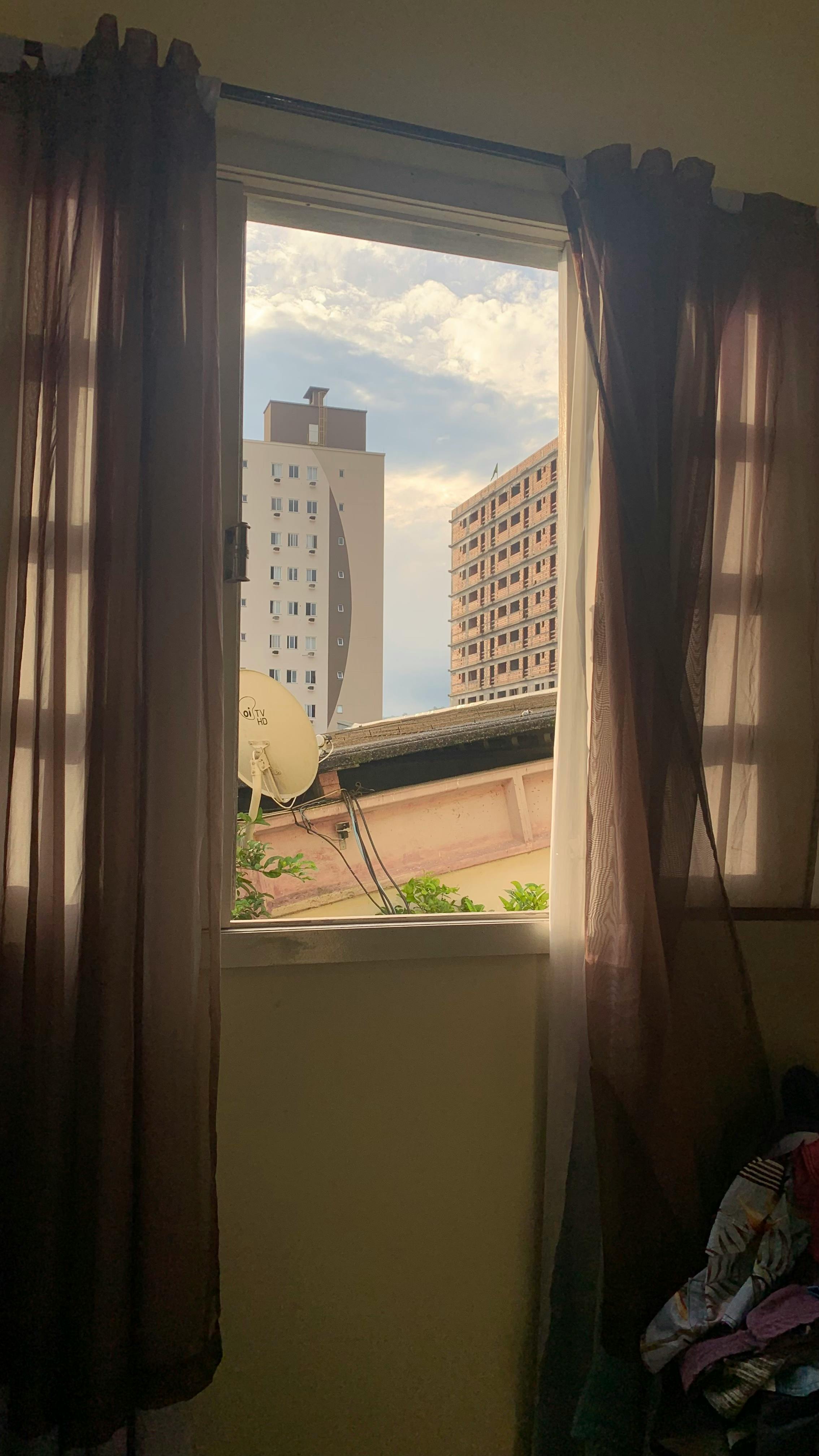 Open Window with a View of City Apartment Buildings · Free Stock Photo