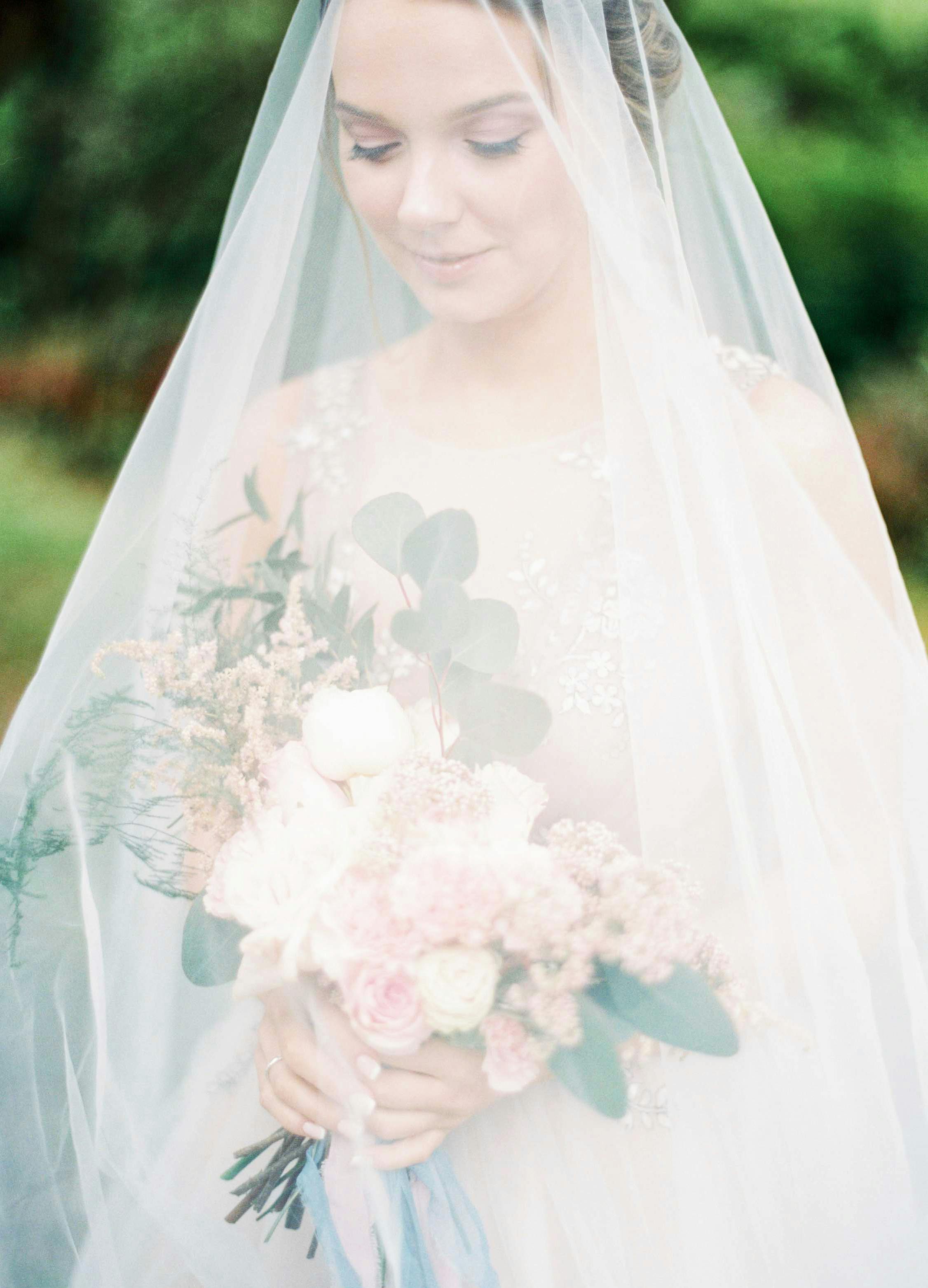 Veiled Bride with a Flower Bouquet · Free Stock Photo