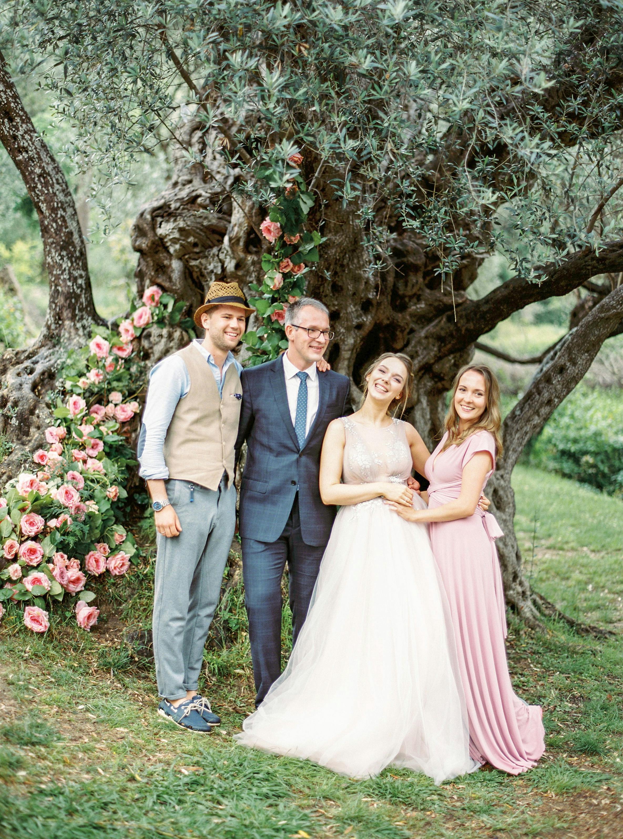 Photo of the Bride and Groom with Witnesses Standing in the Garden ...