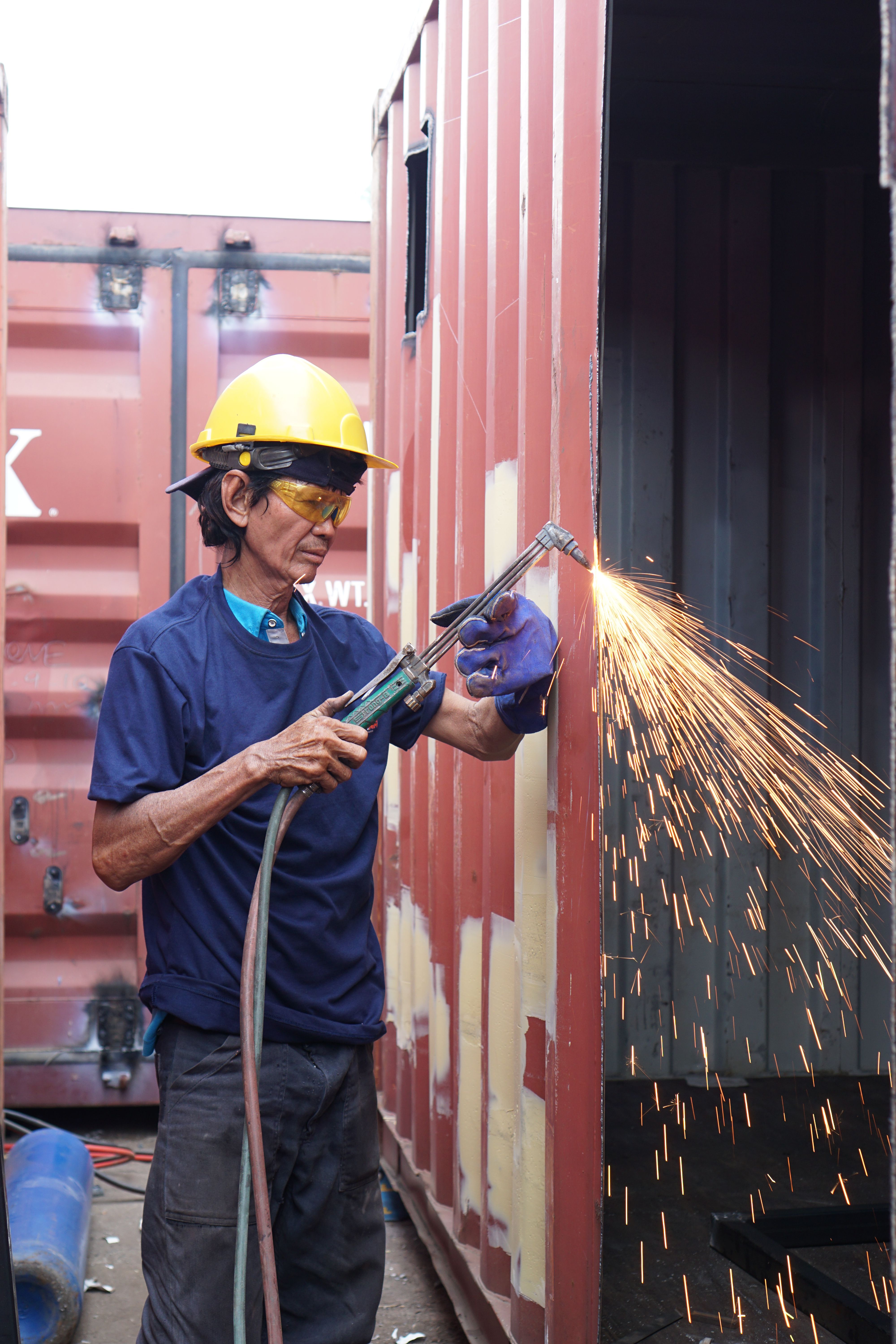 Man Welding Cargo Container · Free Stock Photo