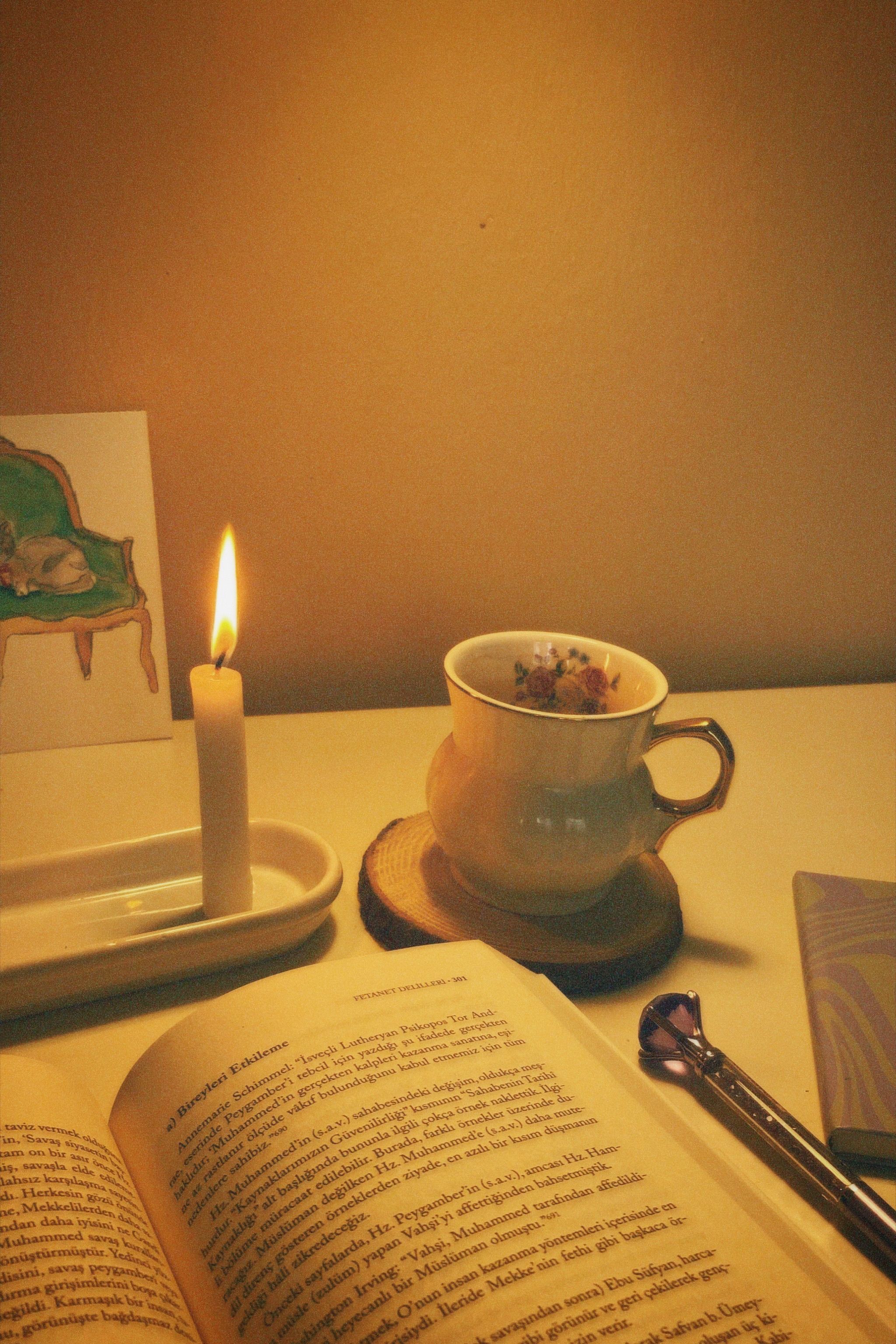 Wax Candle near Book and Cup · Free Stock Photo