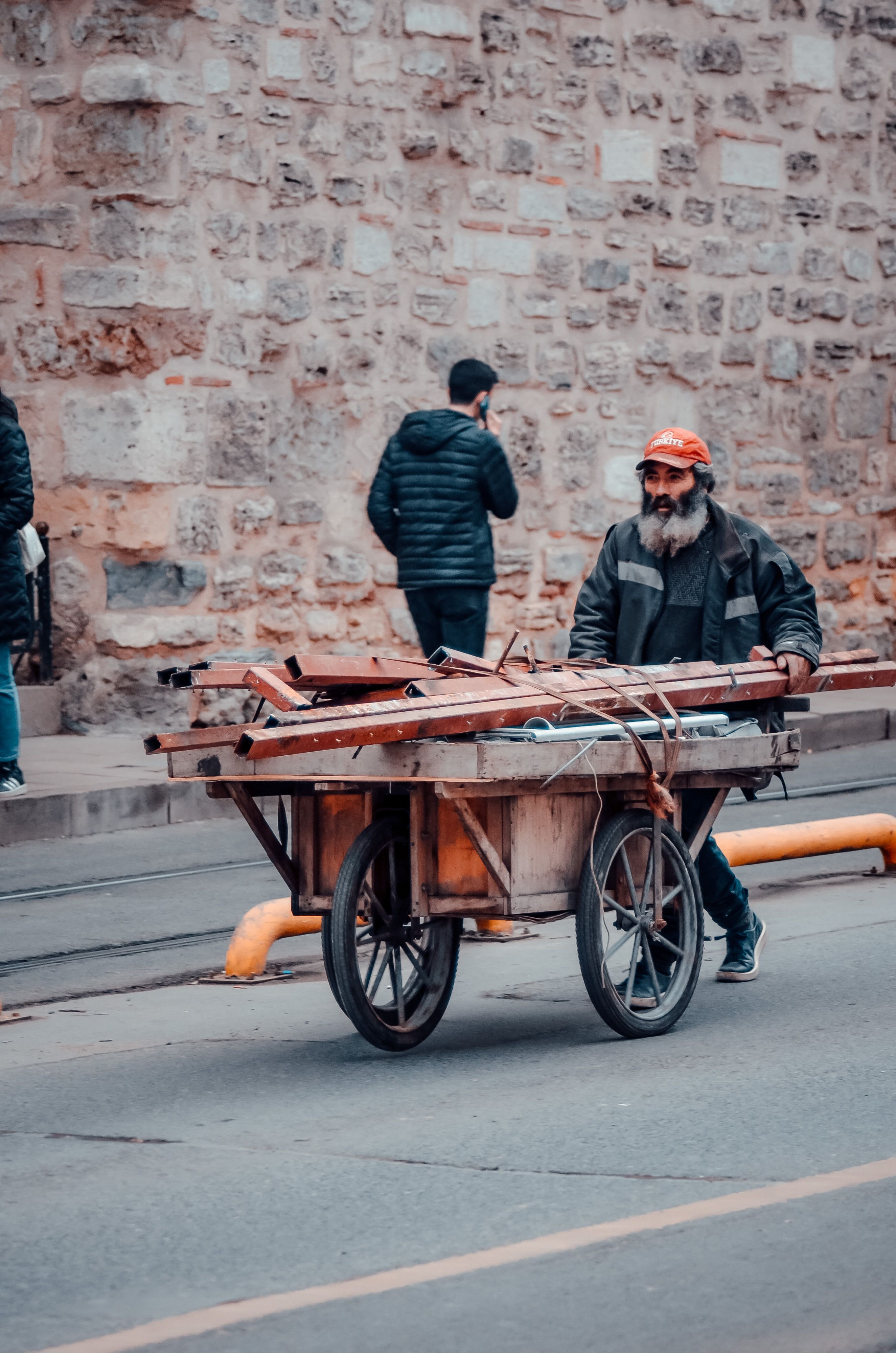 Man Walking with Trailer with Cans · Free Stock Photo