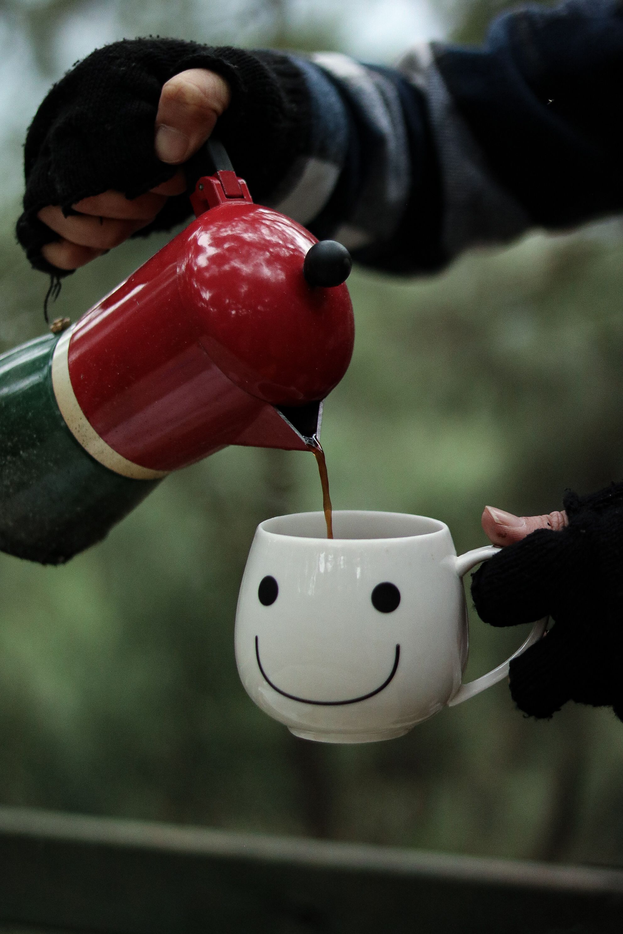 Hand in Glove Pouring Water from Kettle to Sieve over Cup · Free Stock ...