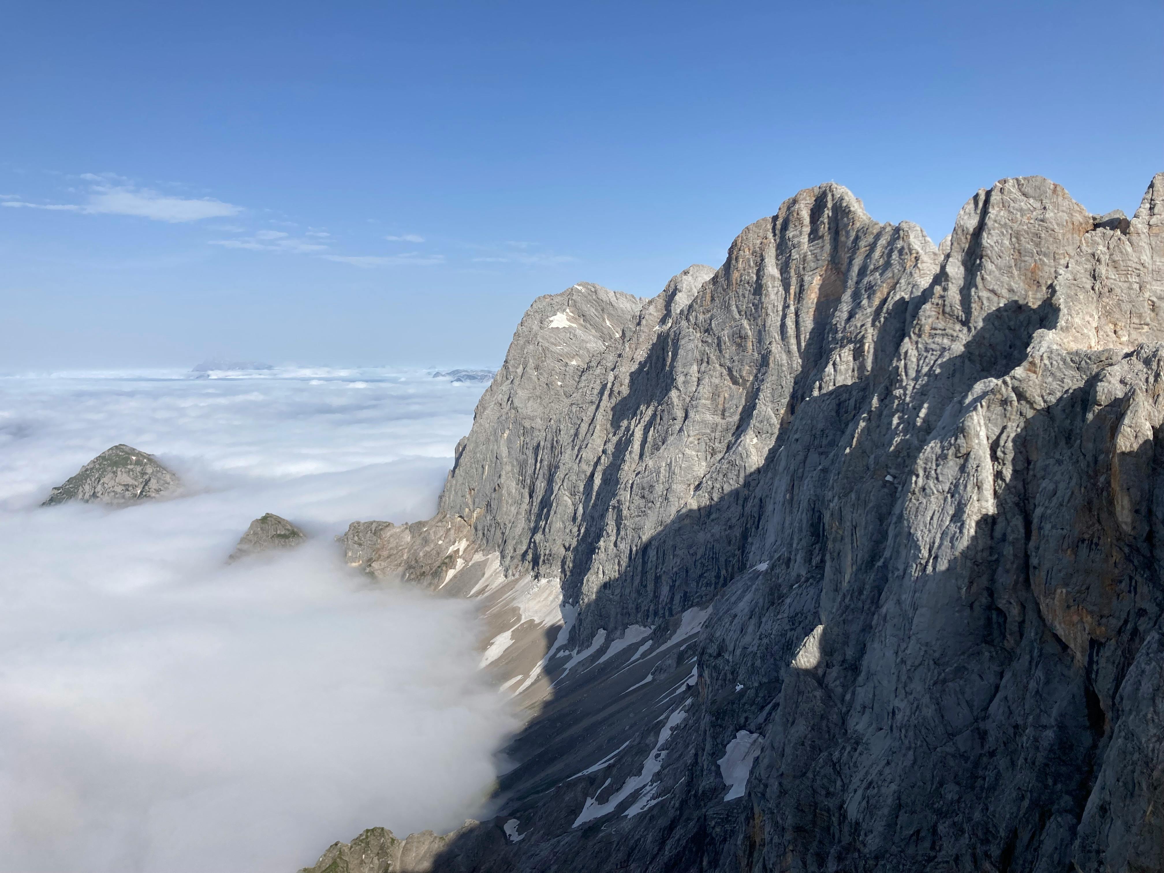 A Green Grass Field Between Mountains · Free Stock Photo