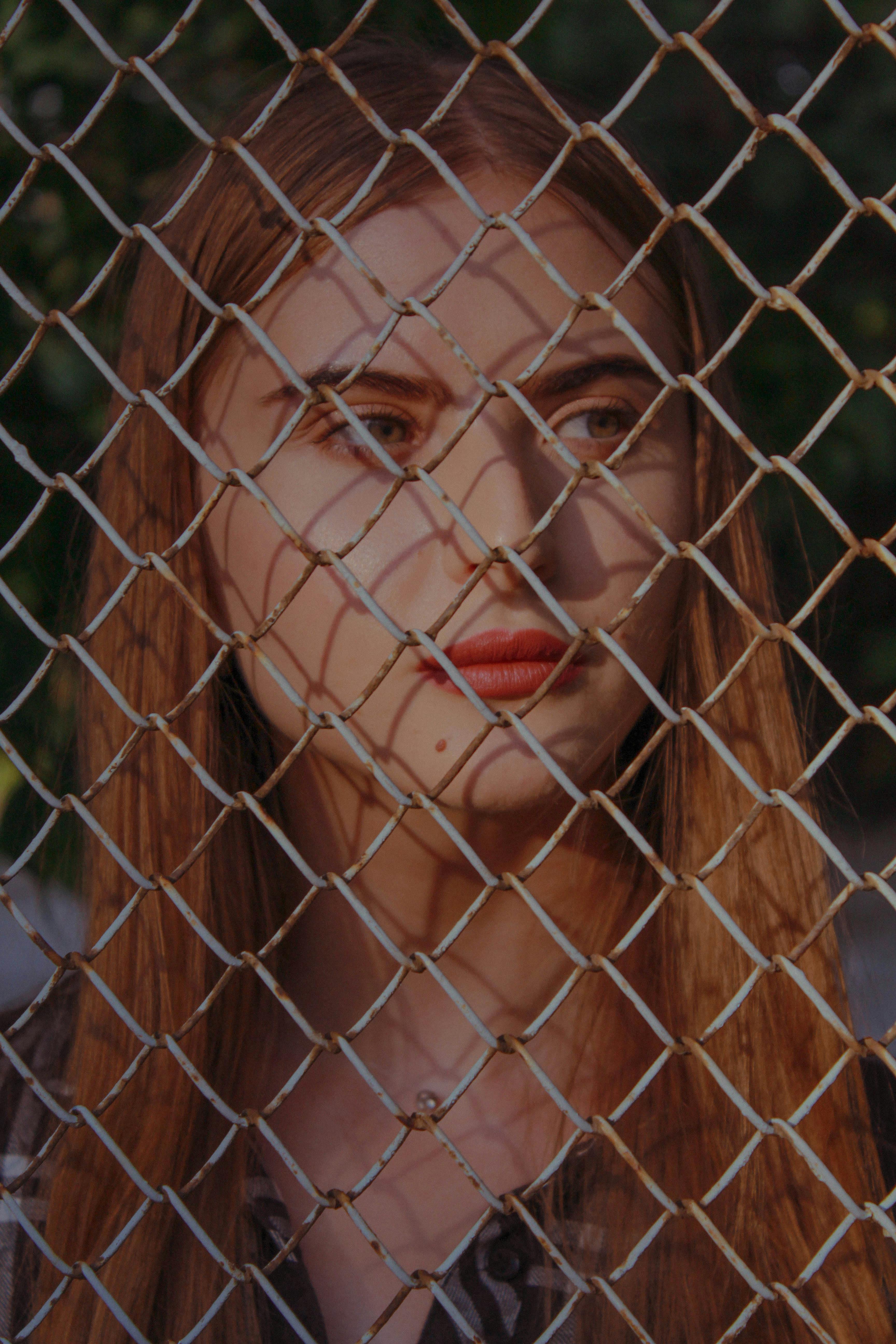 Portrait of Woman behind Fence Net · Free Stock Photo