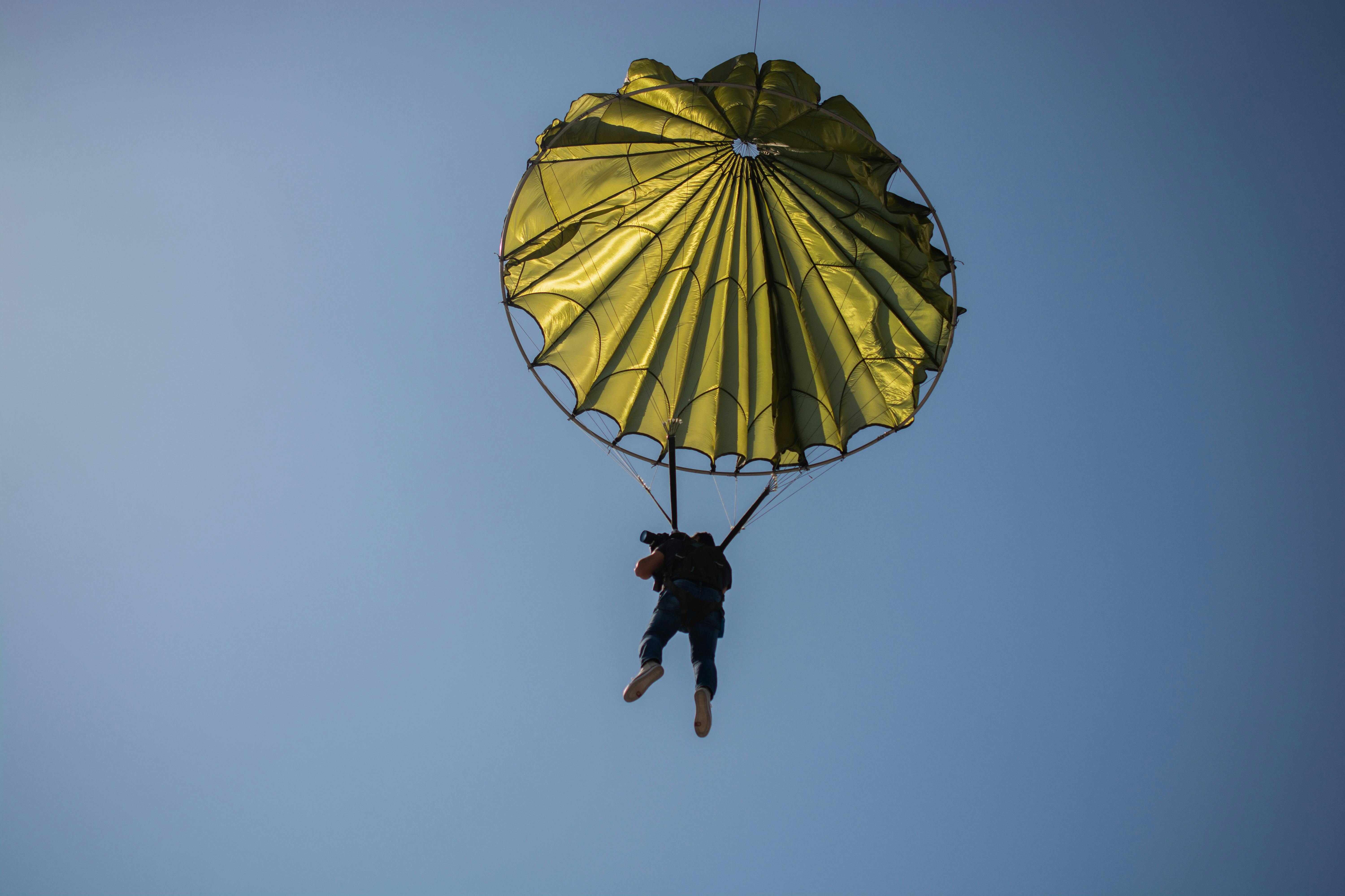 Person Parachuting under Clouds · Free Stock Photo
