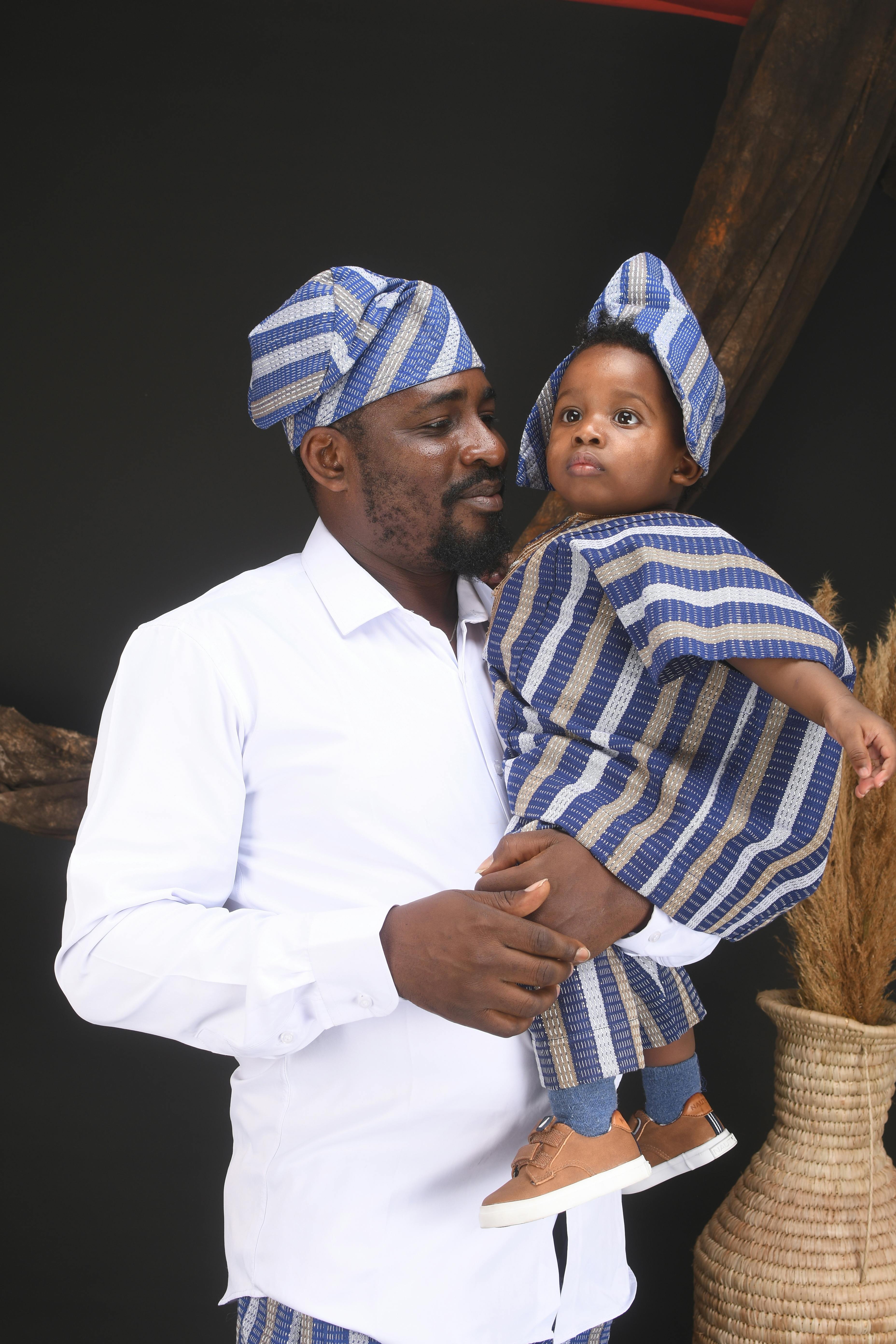Father Working From Home With Child on His Back · Free Stock Photo