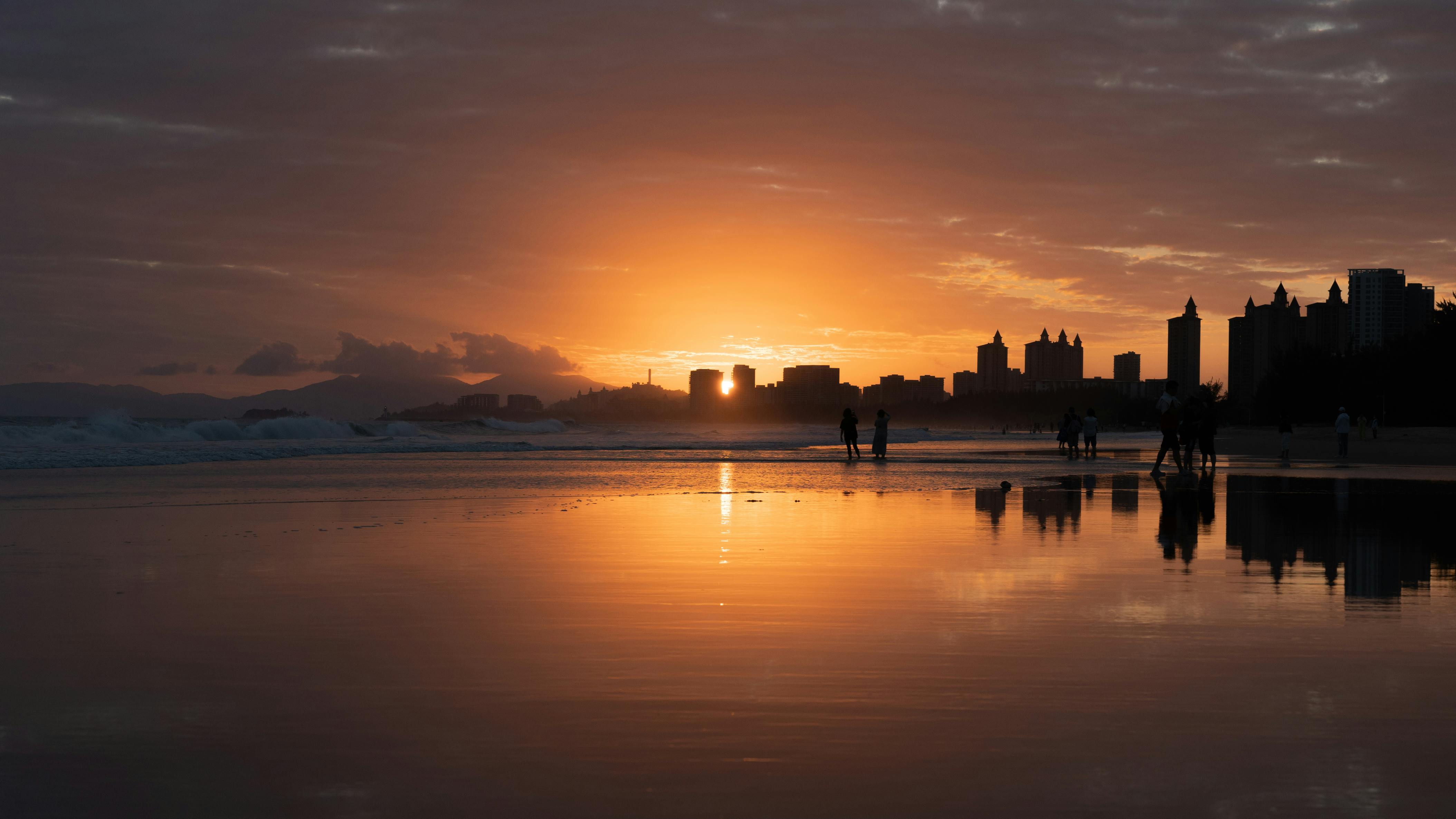 A Beach with a View of the Skyline of a City during the Golden Hour ...