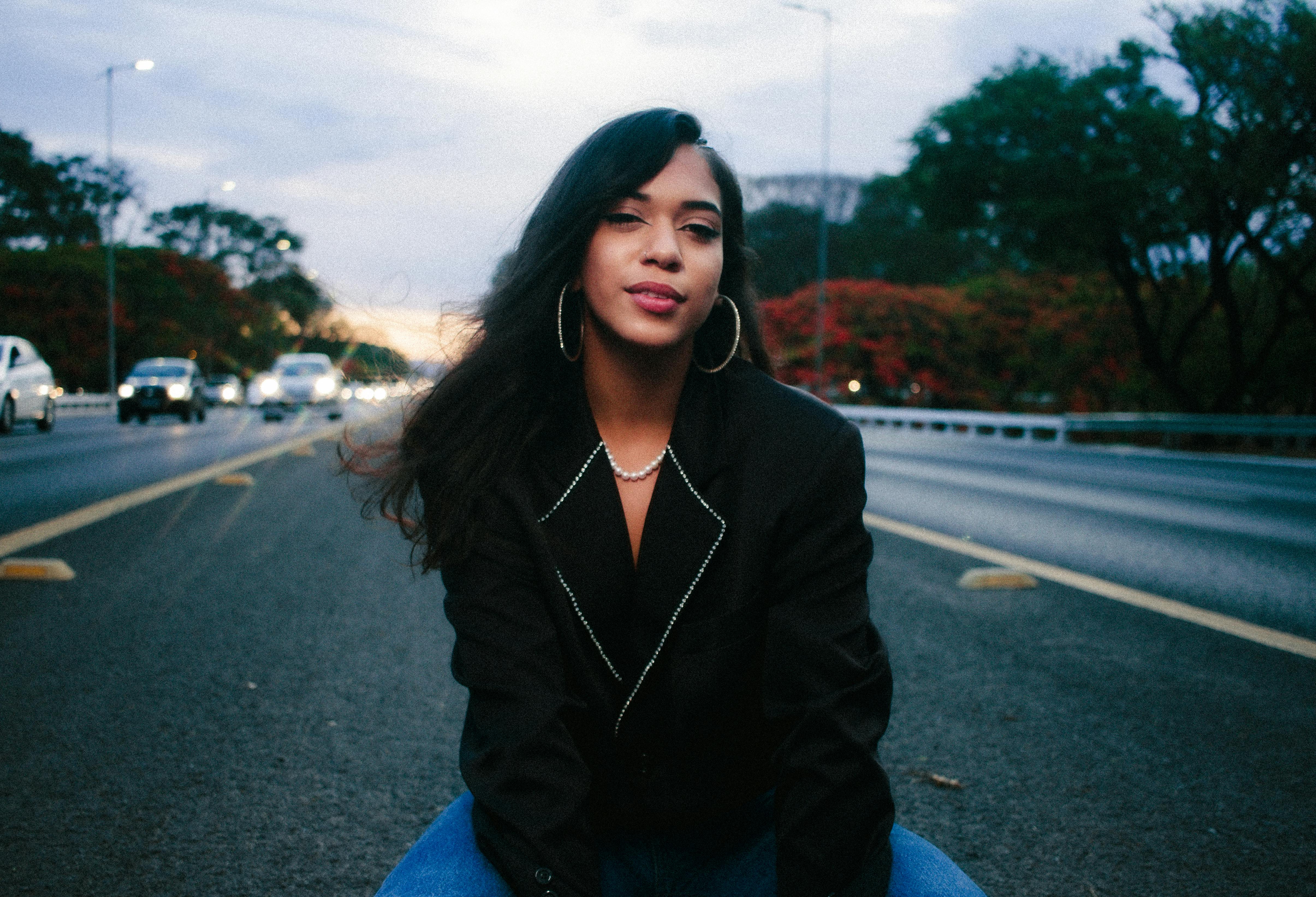 Portrait of a Female Model Crouching in the Middle of the Street · Free ...
