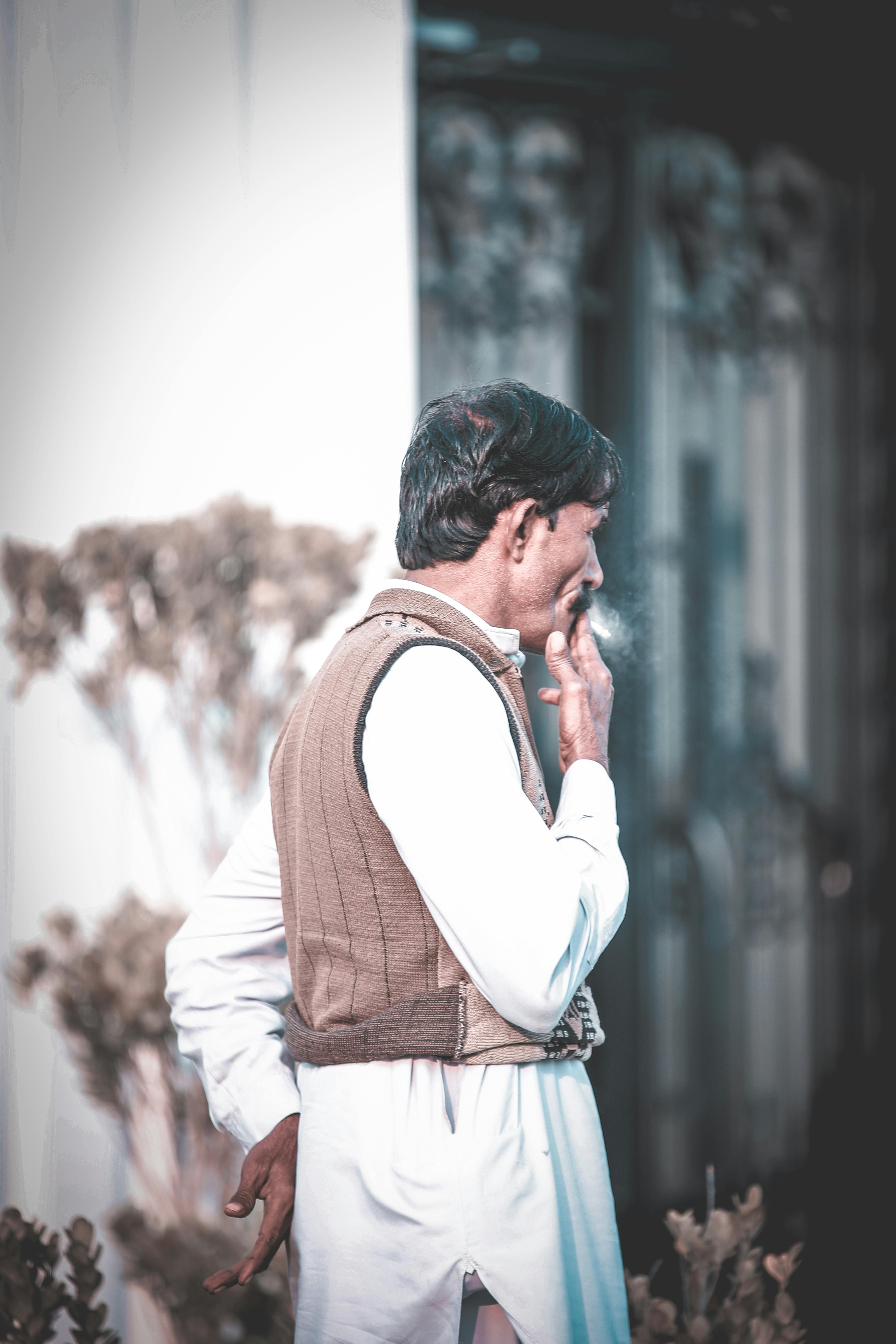 Man Standing and Smoking · Free Stock Photo