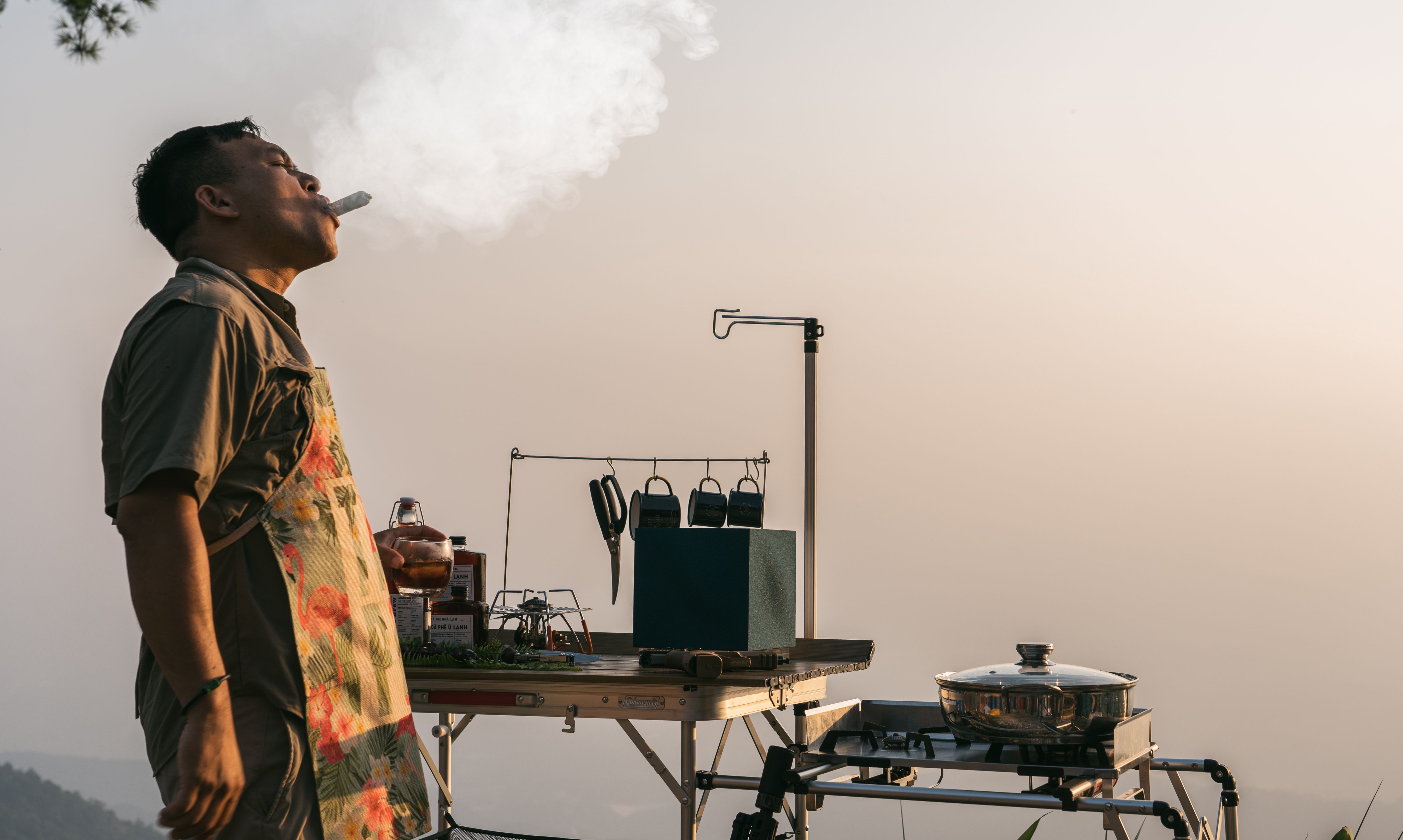 Man Smoking a Cigar and Cooking Outside · Free Stock Photo