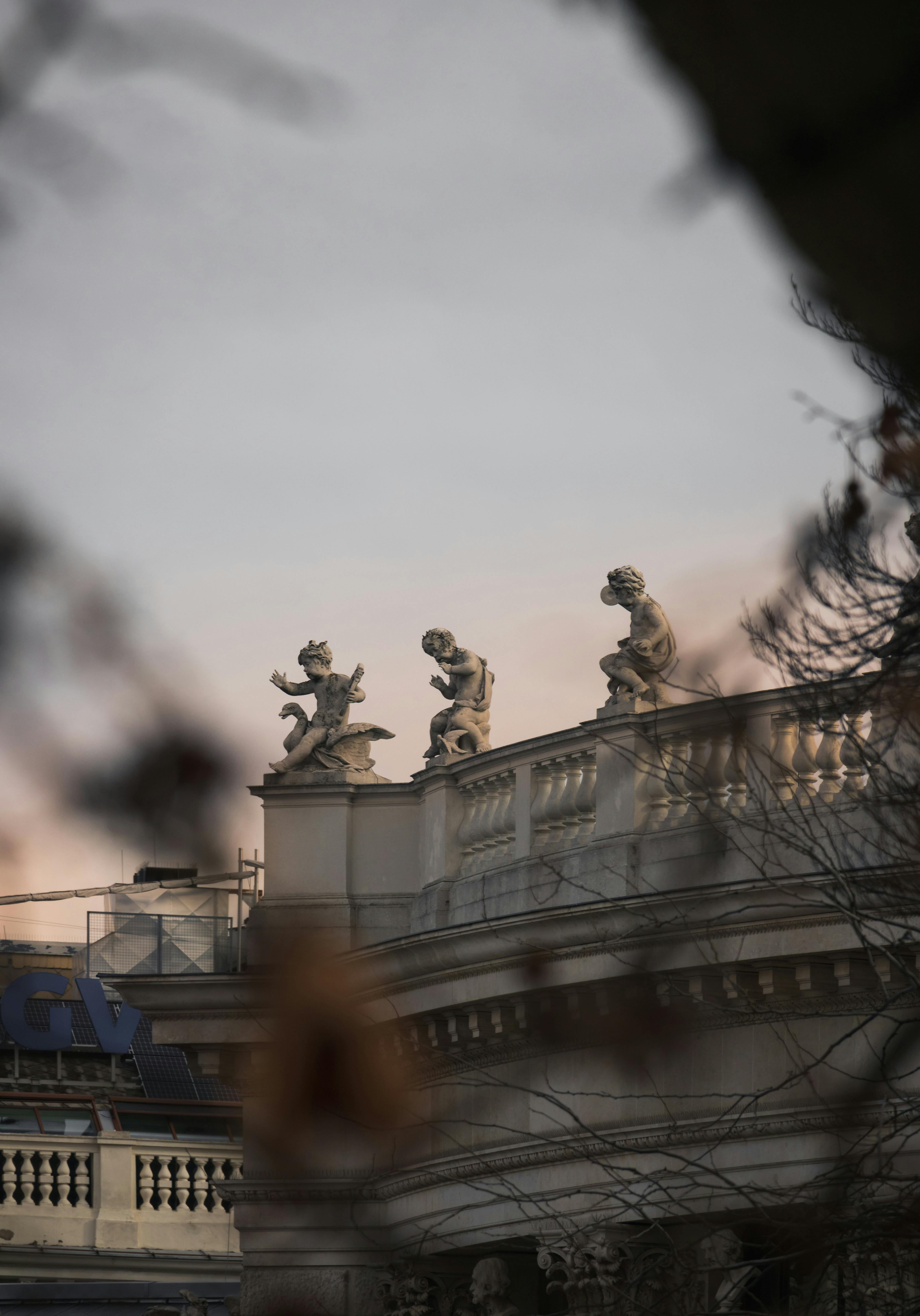 Concrete Statues on Top of the Building · Free Stock Photo