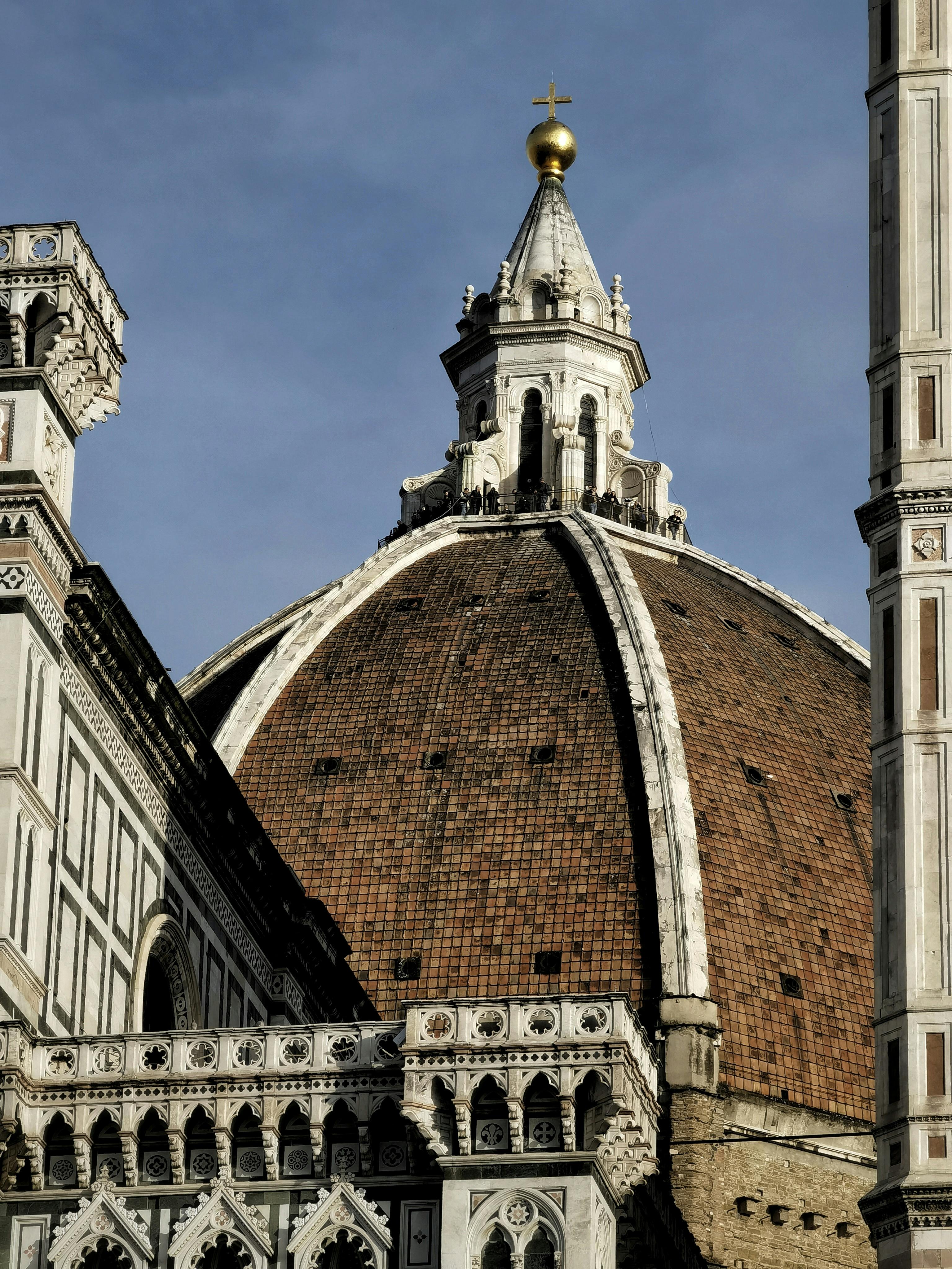 Brown and White Painted Cathedral Roof Overlooking City and Mountain ...