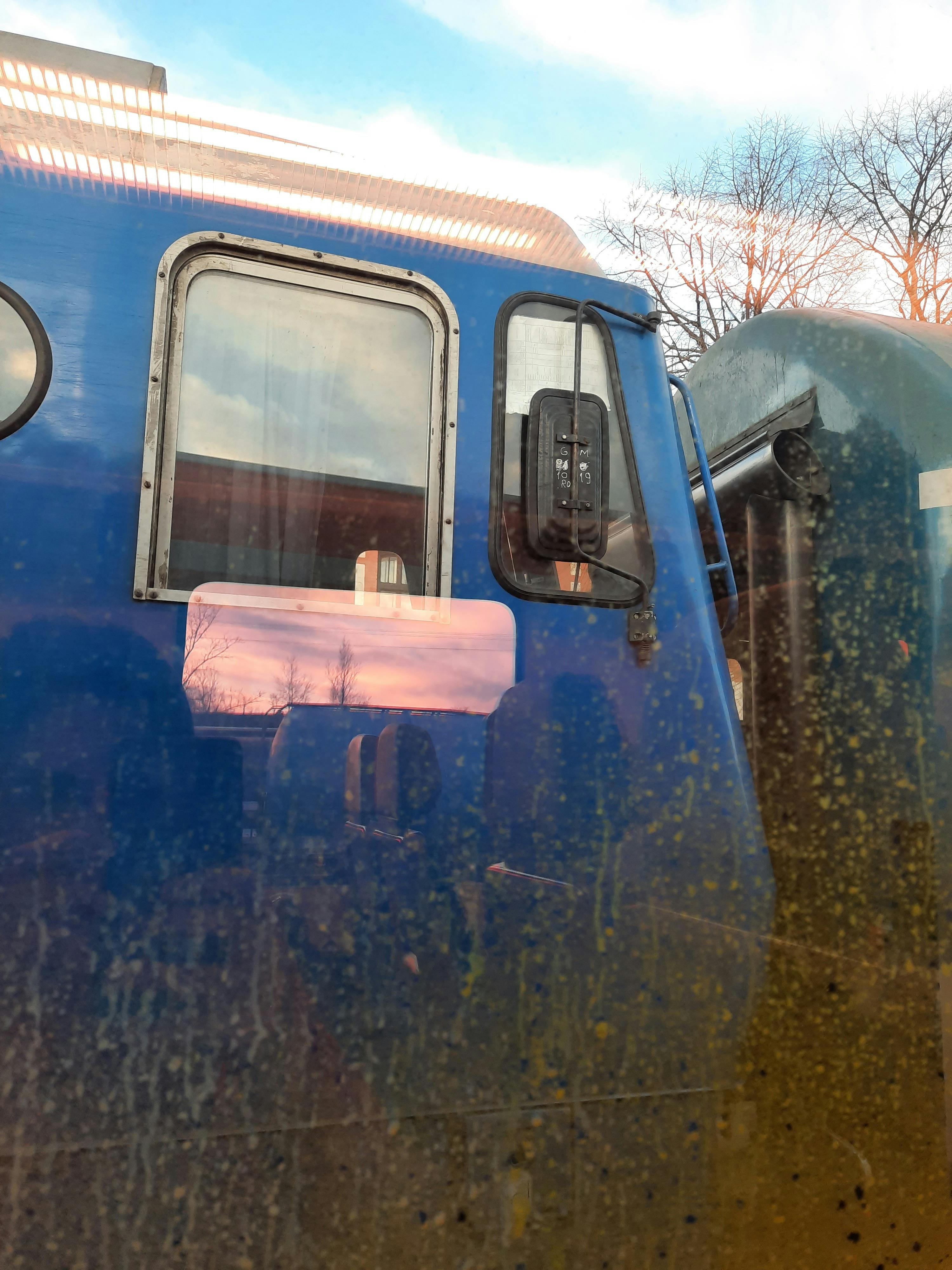 Train Wagons seen from Behind a Dirty Window · Free Stock Photo