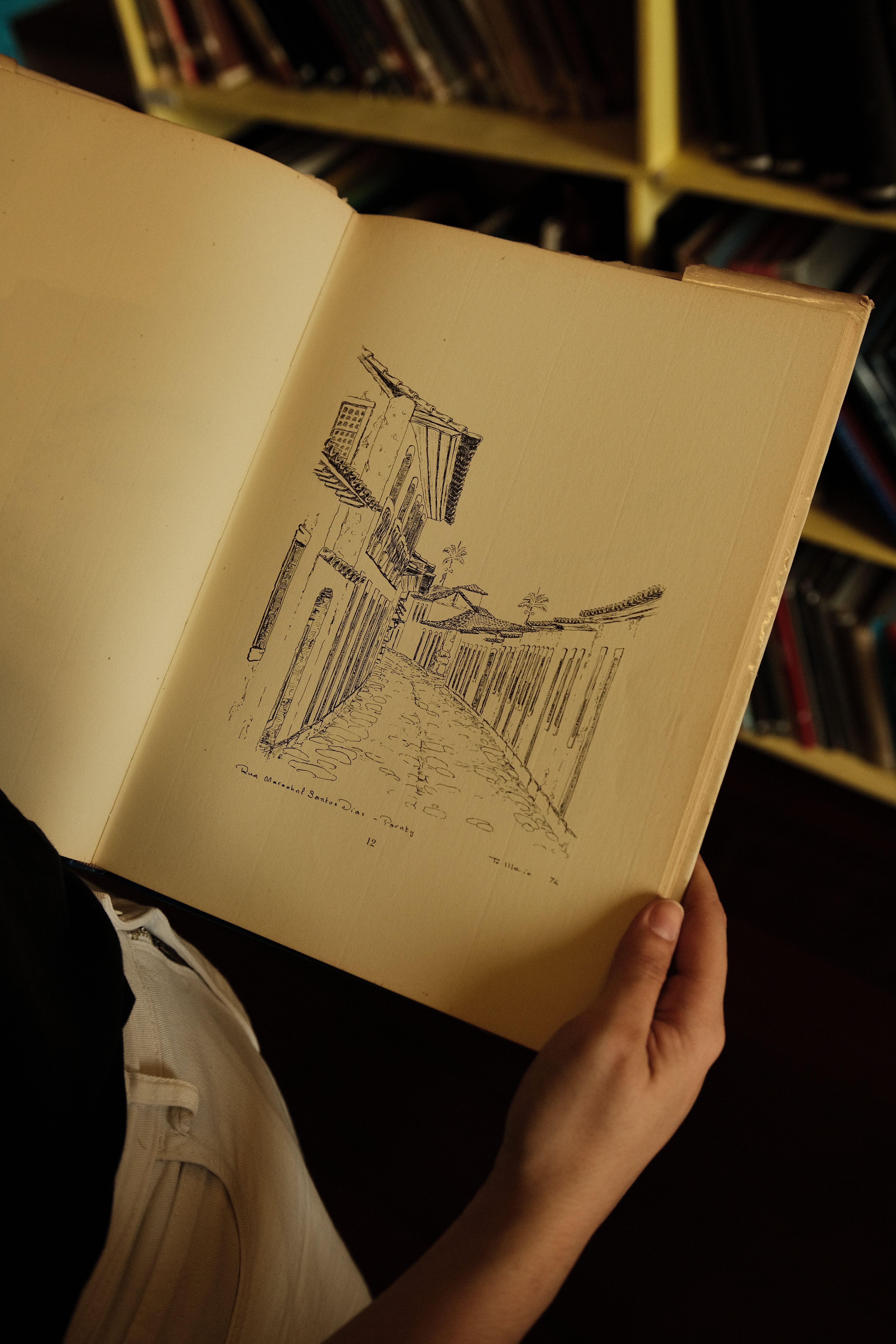 Woman Hand Holding Book with Drawing on Page · Free Stock Photo