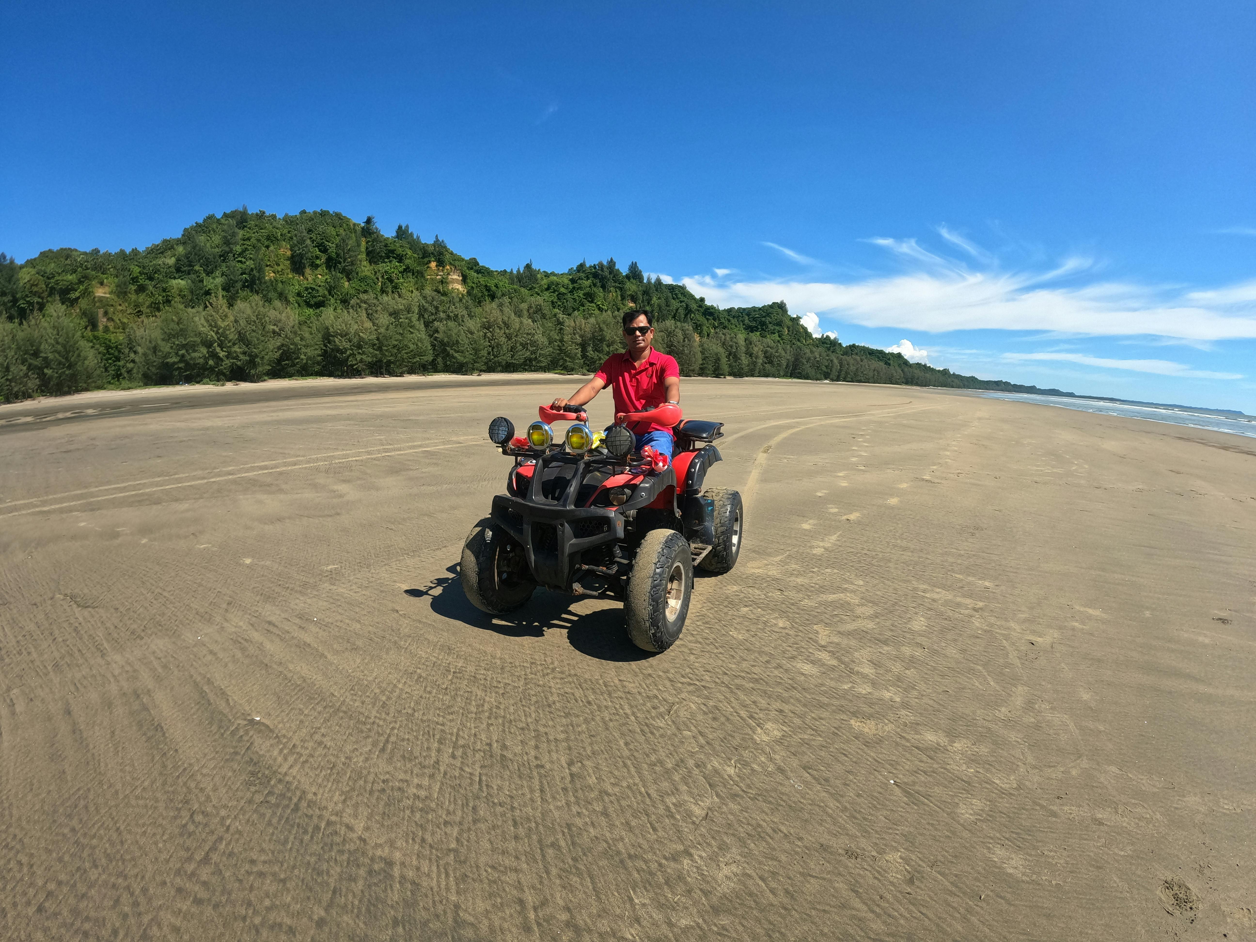 Man Posing on Quad on Beach · Free Stock Photo