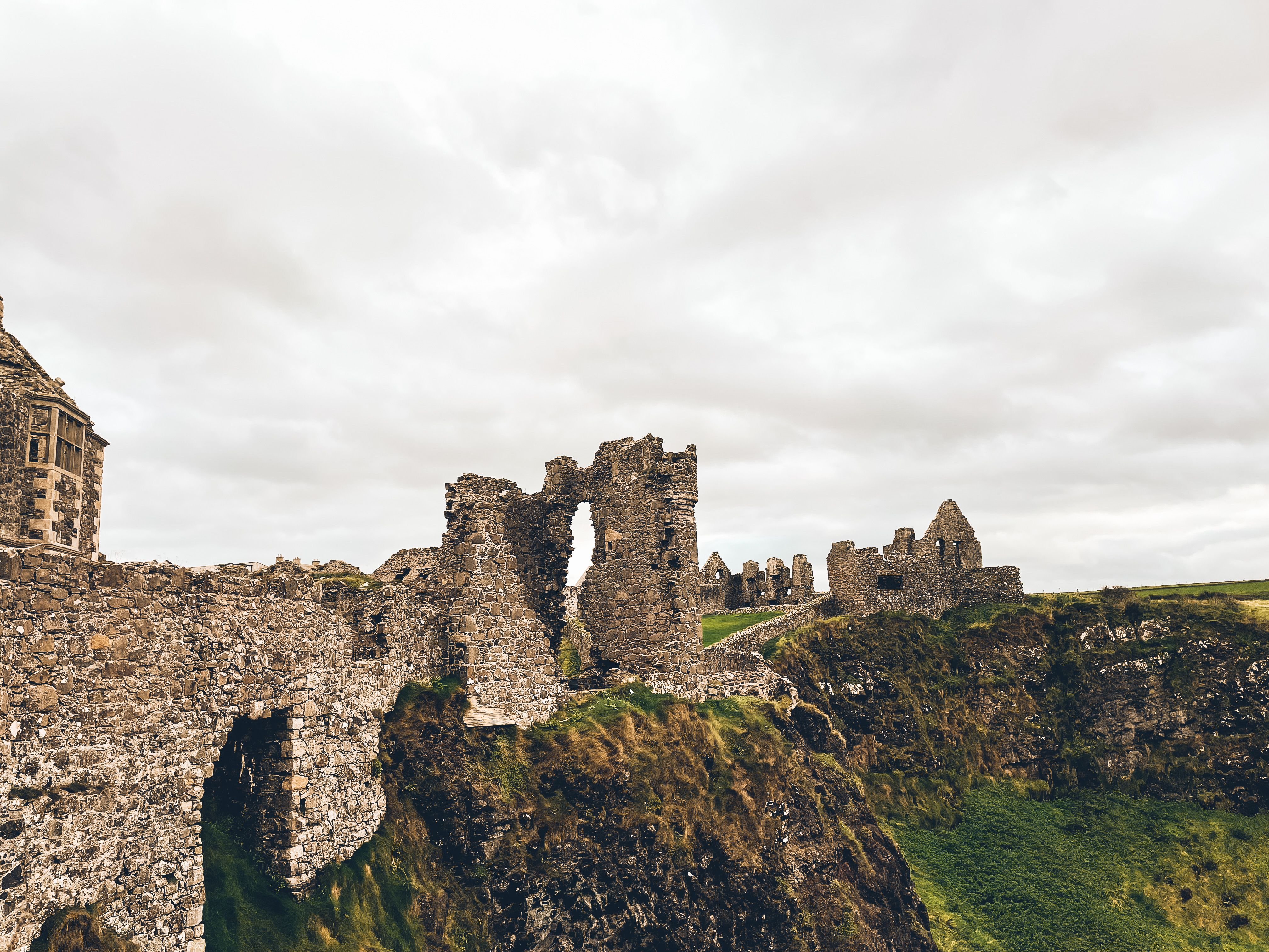 old medieval ruins of Dunluce Castle on ocean coast in northern Ireland ...