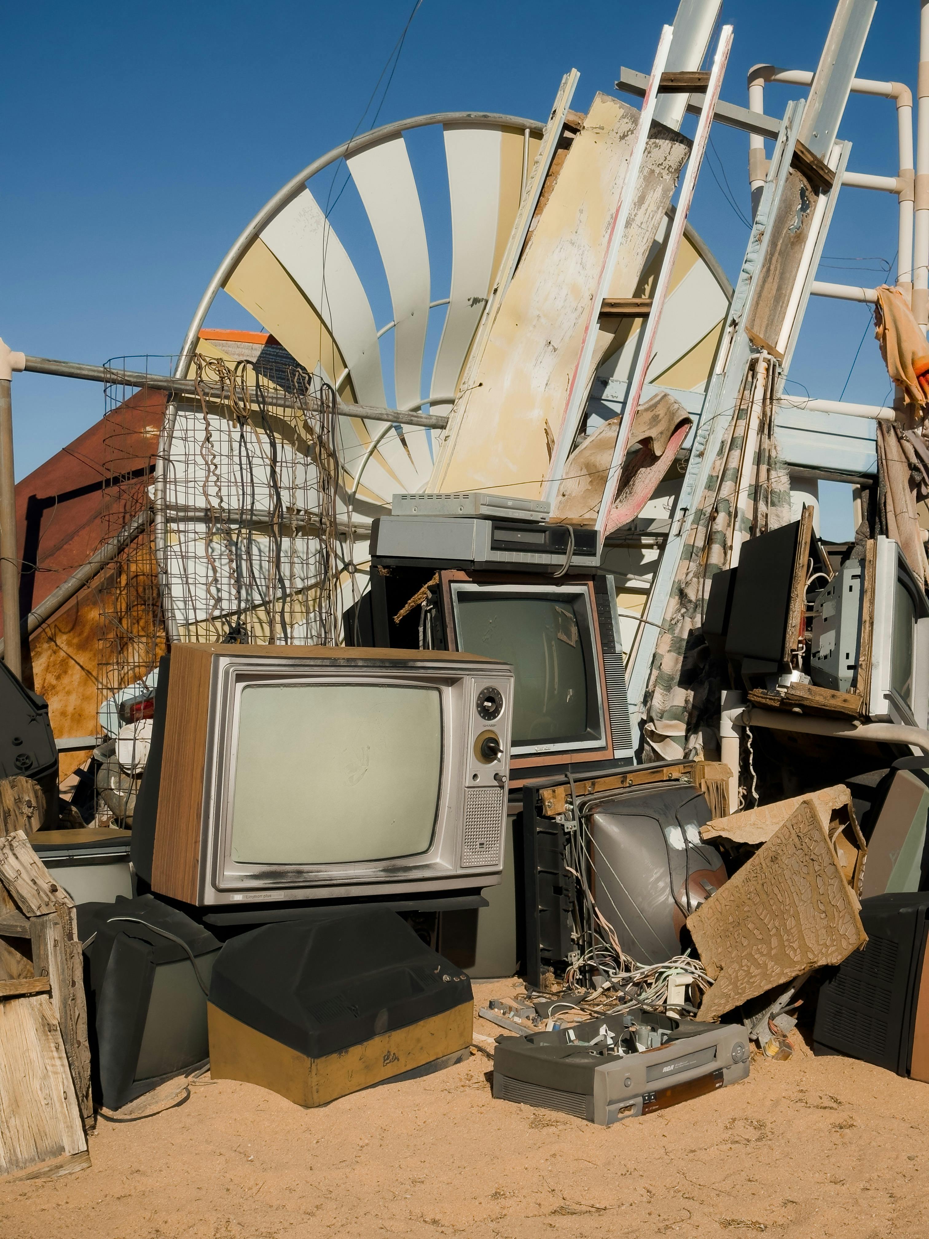 Old Broken Televisions in a Junkyard · Free Stock Photo