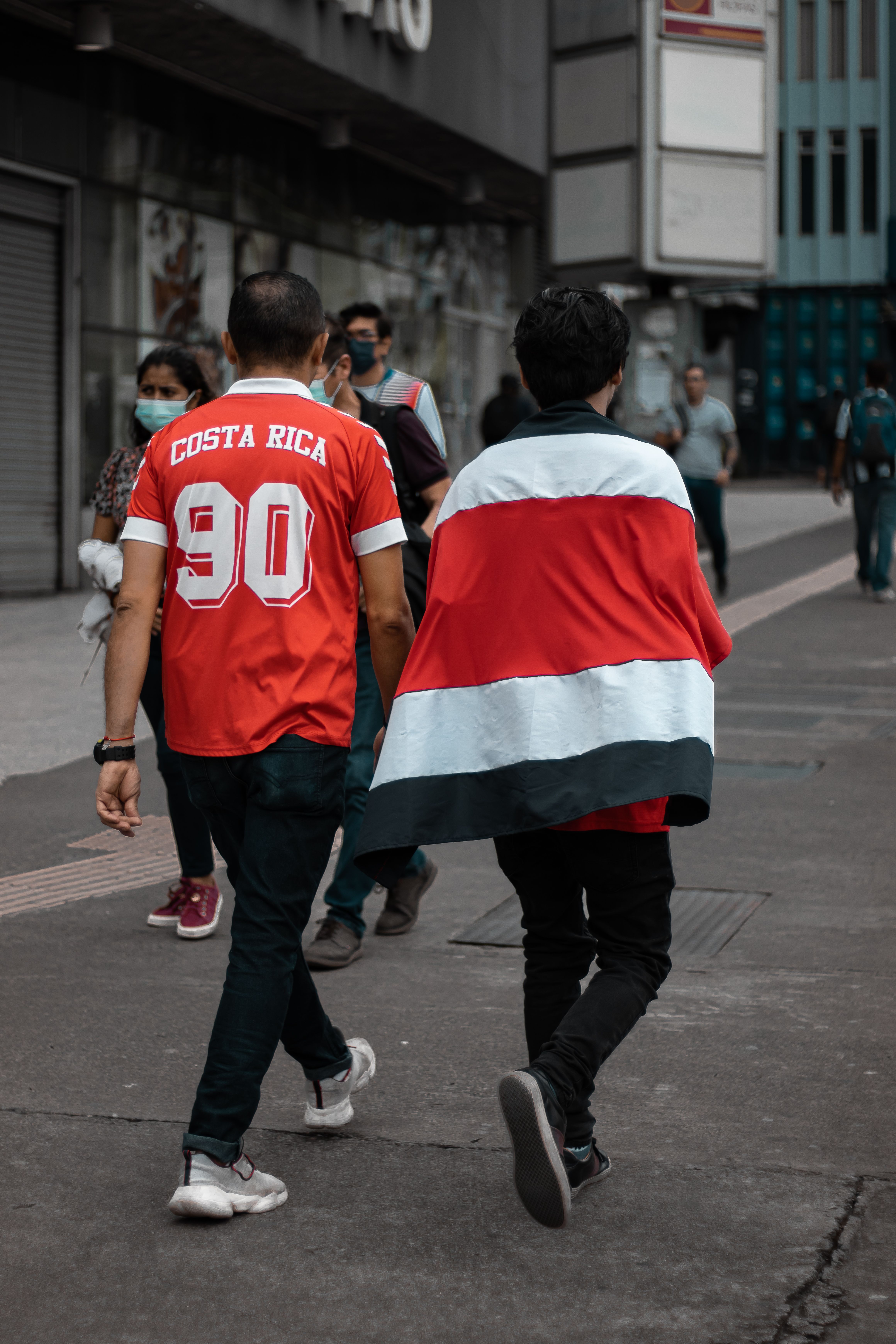 Football Fans Walking Sidewalk · Free Stock Photo