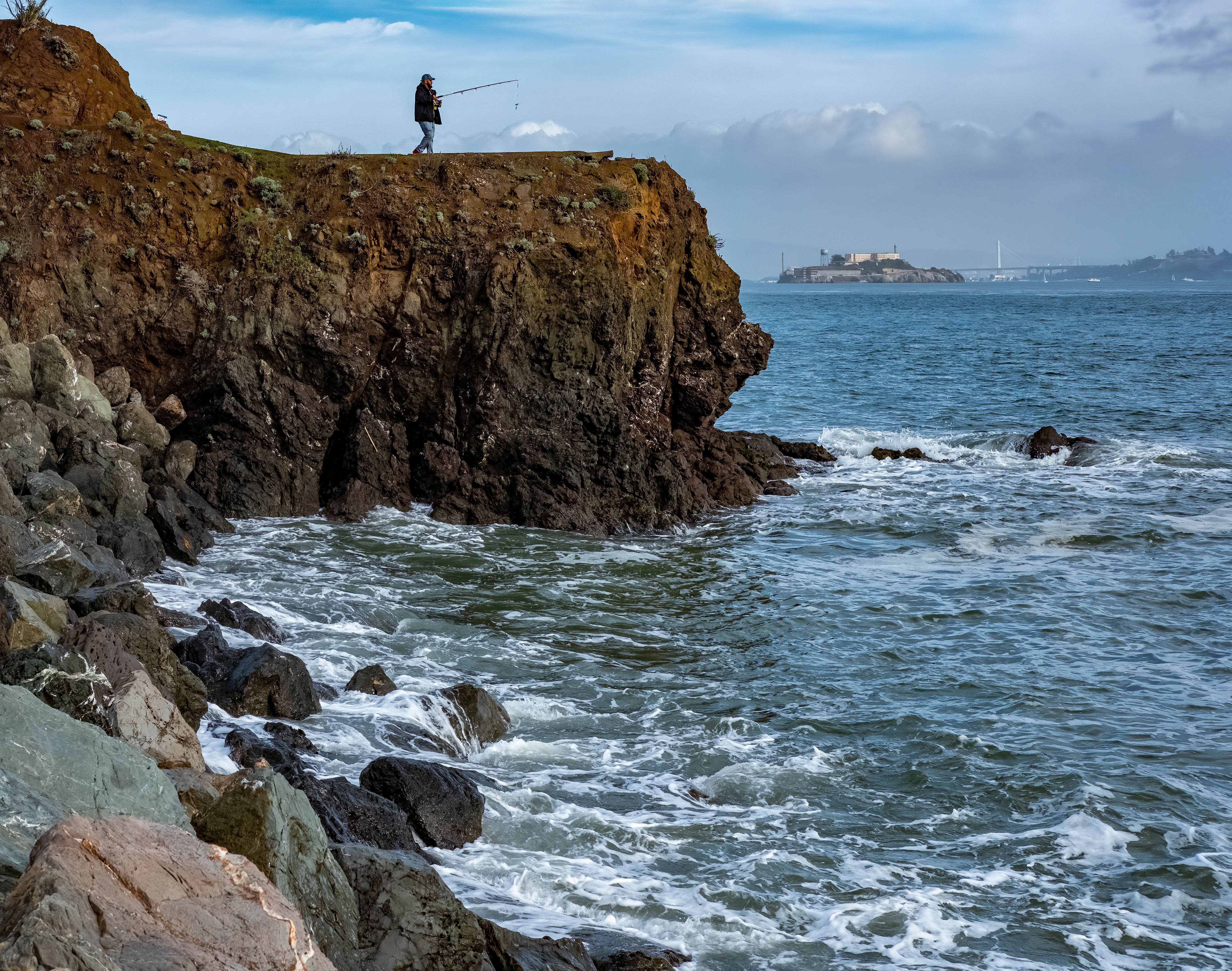 Person on Cliff on Sea Shore · Free Stock Photo