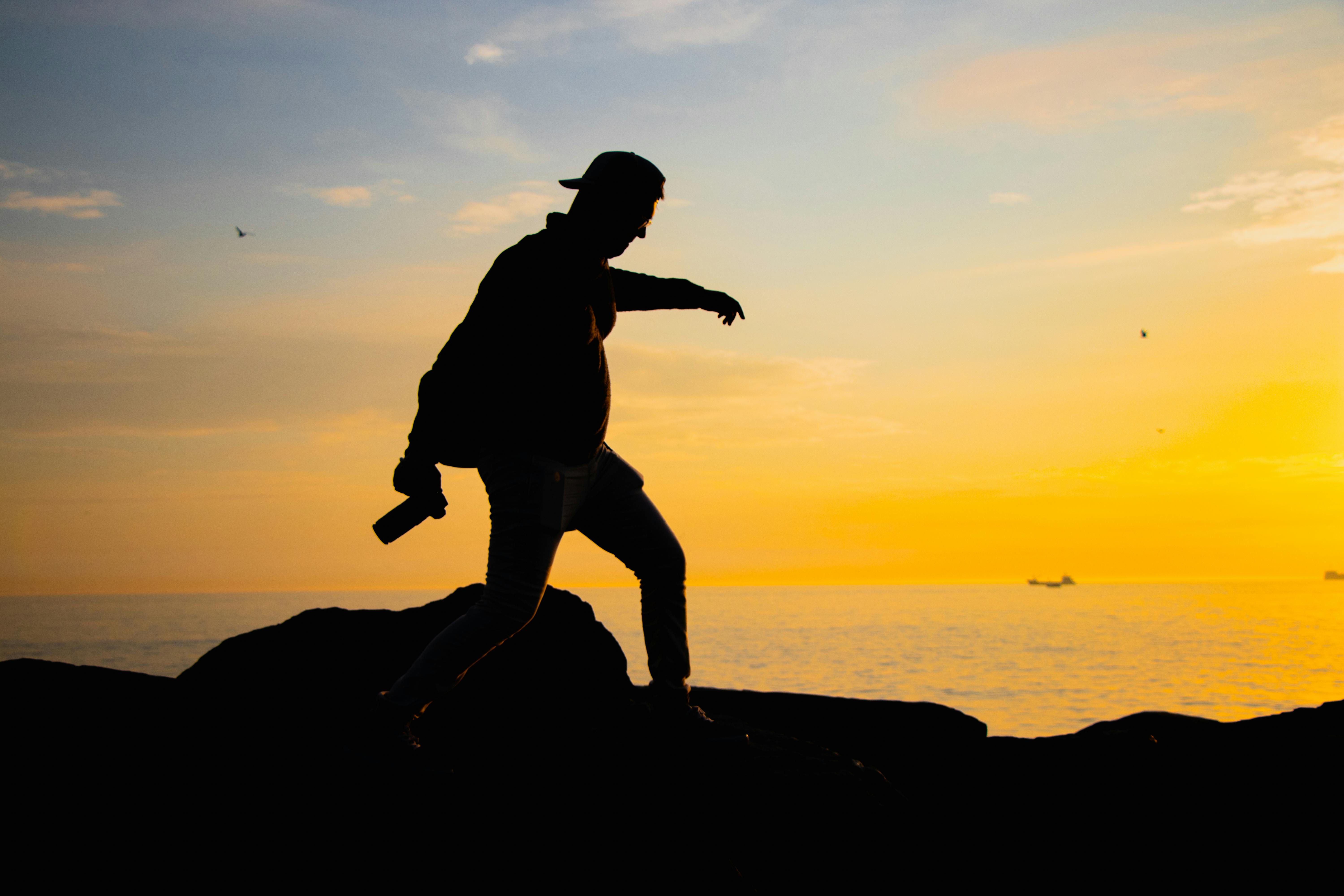 Man on Rocks at Sunset · Free Stock Photo
