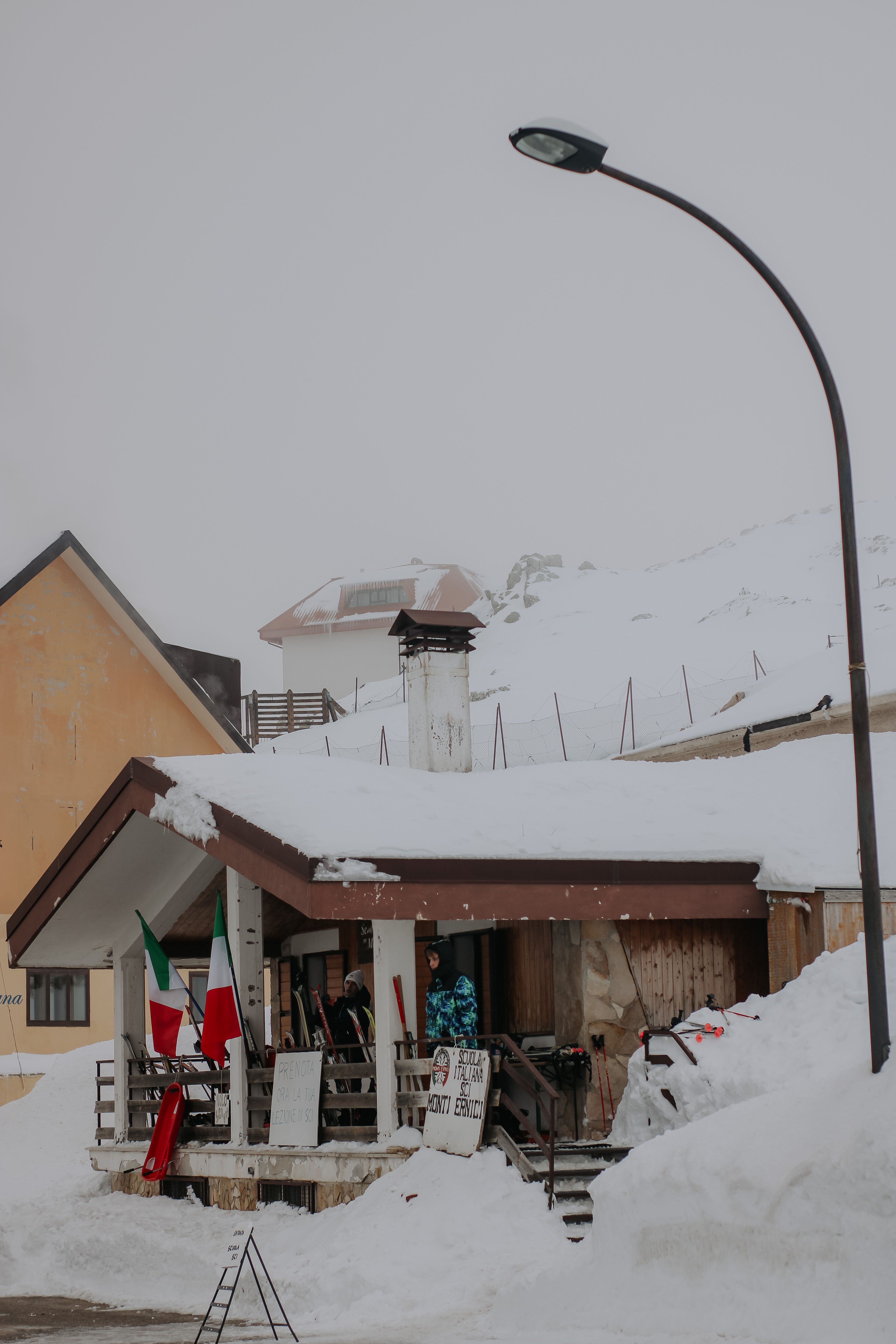 Building with Flags in Winter Landscape · Free Stock Photo