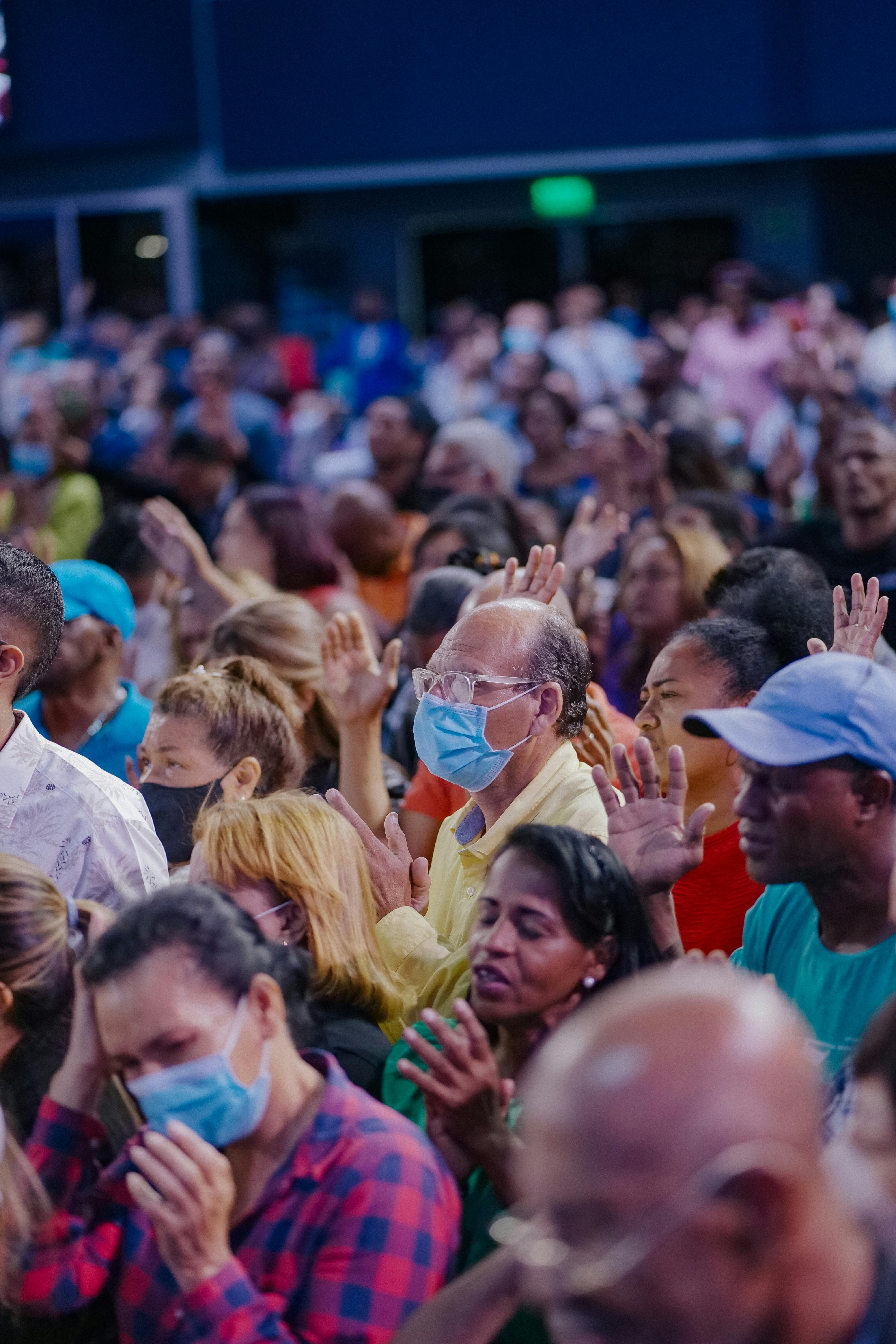 People Praying at Gathering on Stadium · Free Stock Photo