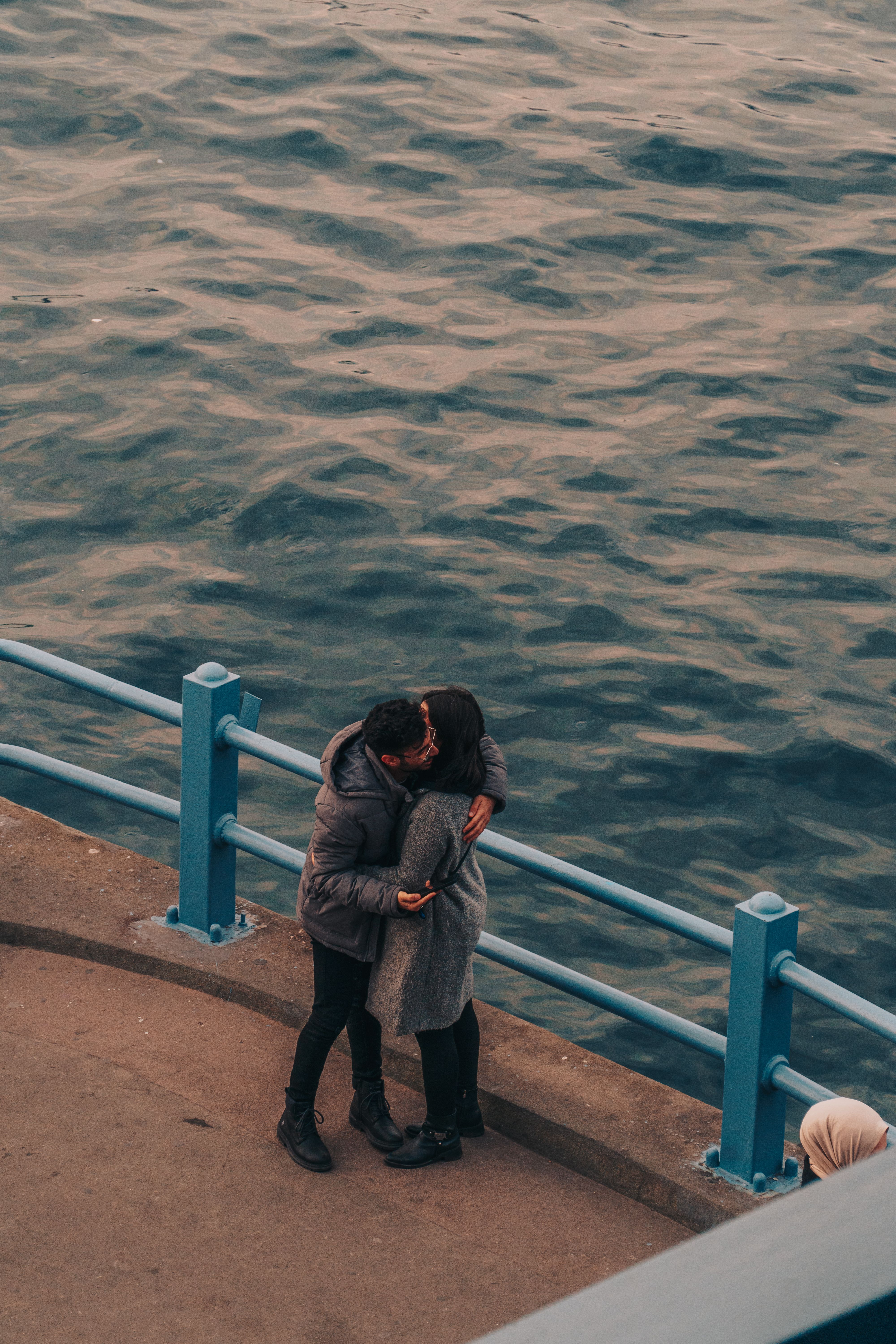 Man Hugging Woman near Water · Free Stock Photo