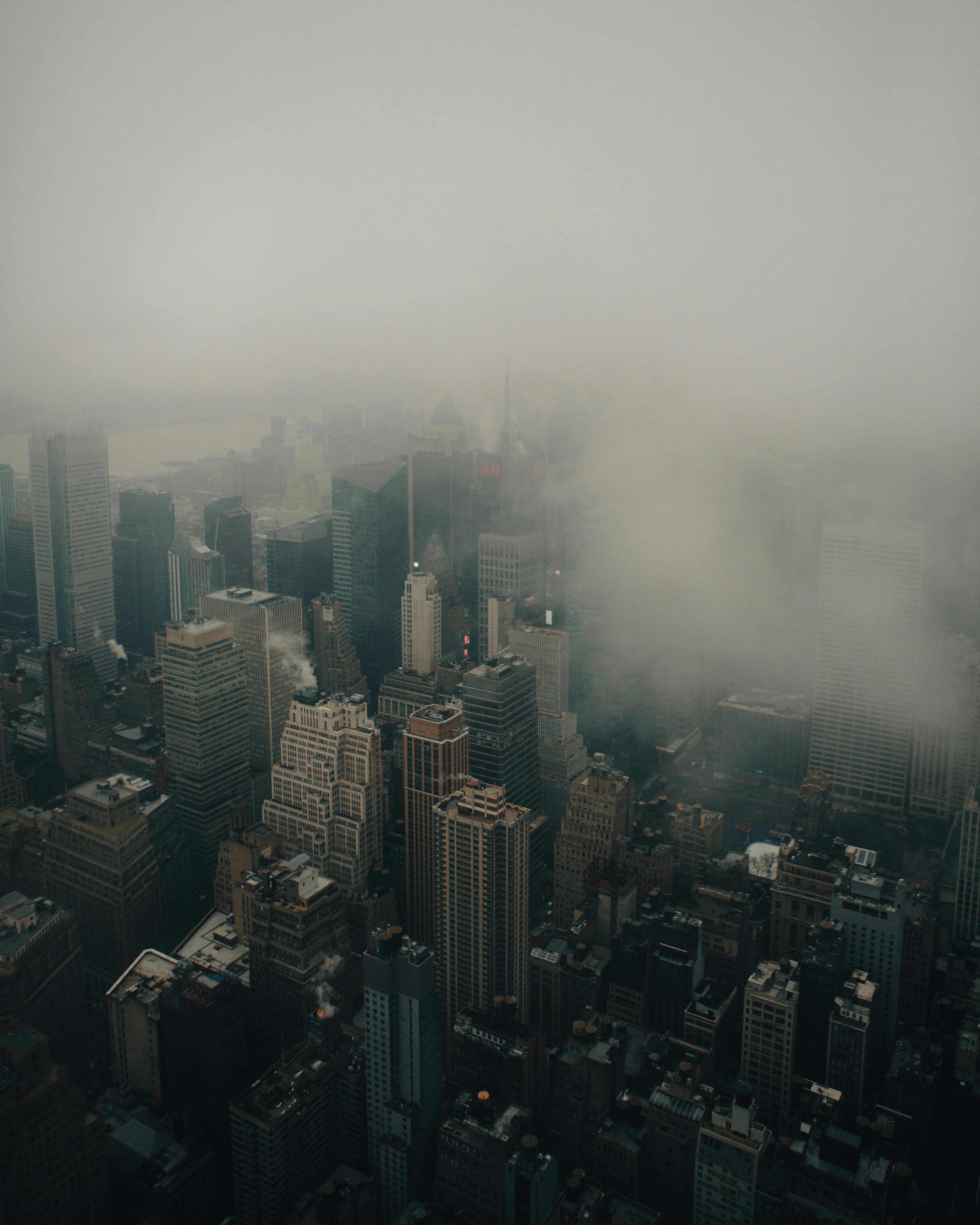 Low-angle Photography of Buildings Covered by Fog · Free Stock Photo