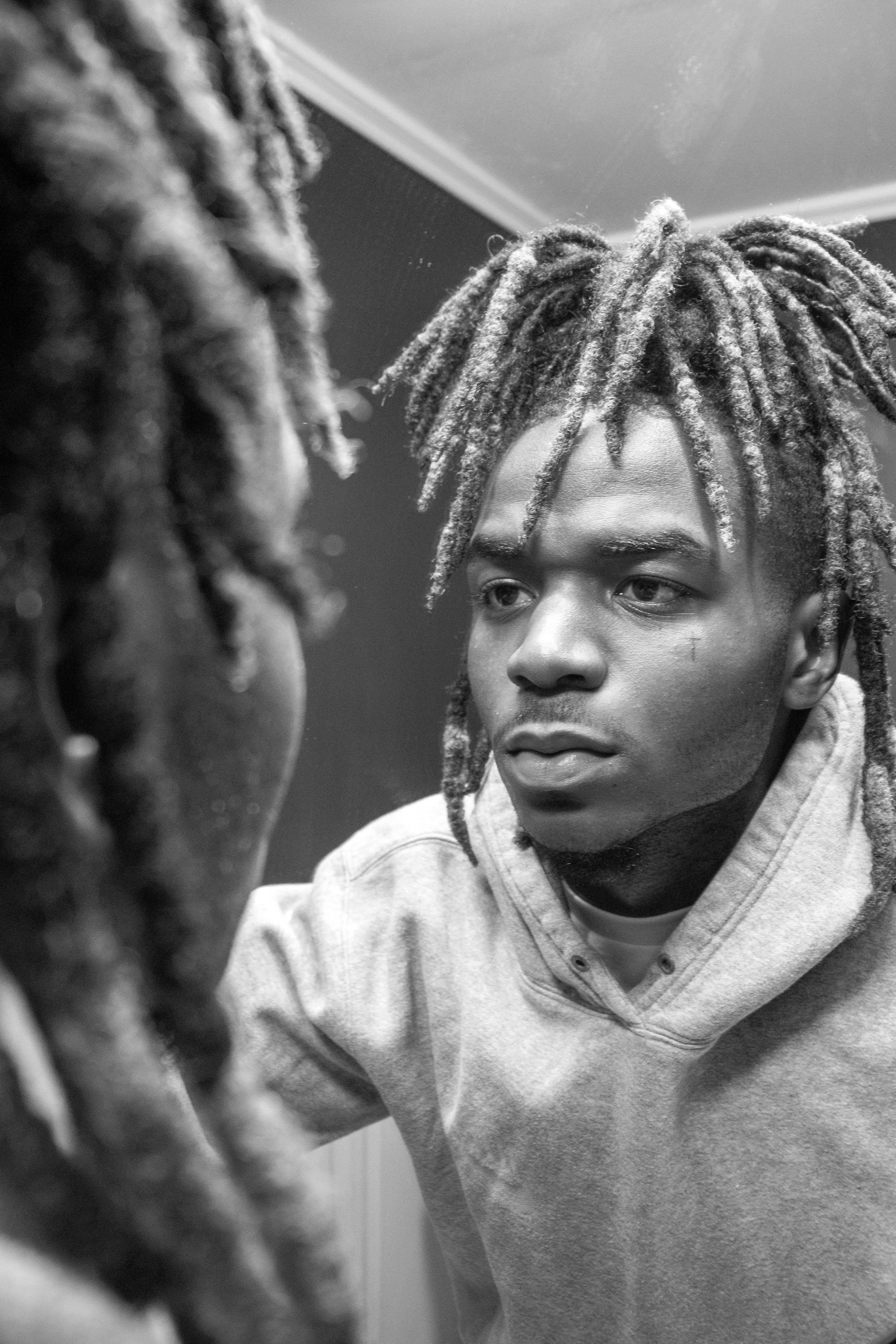 Man with Dreadlocks Looking in Mirror · Free Stock Photo